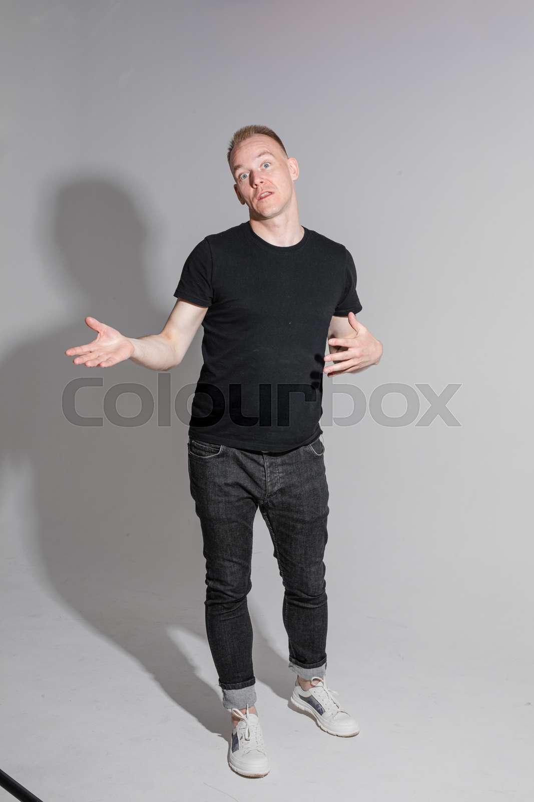 happy man keeping his hands up and smiles | Stock image | Colourbox
