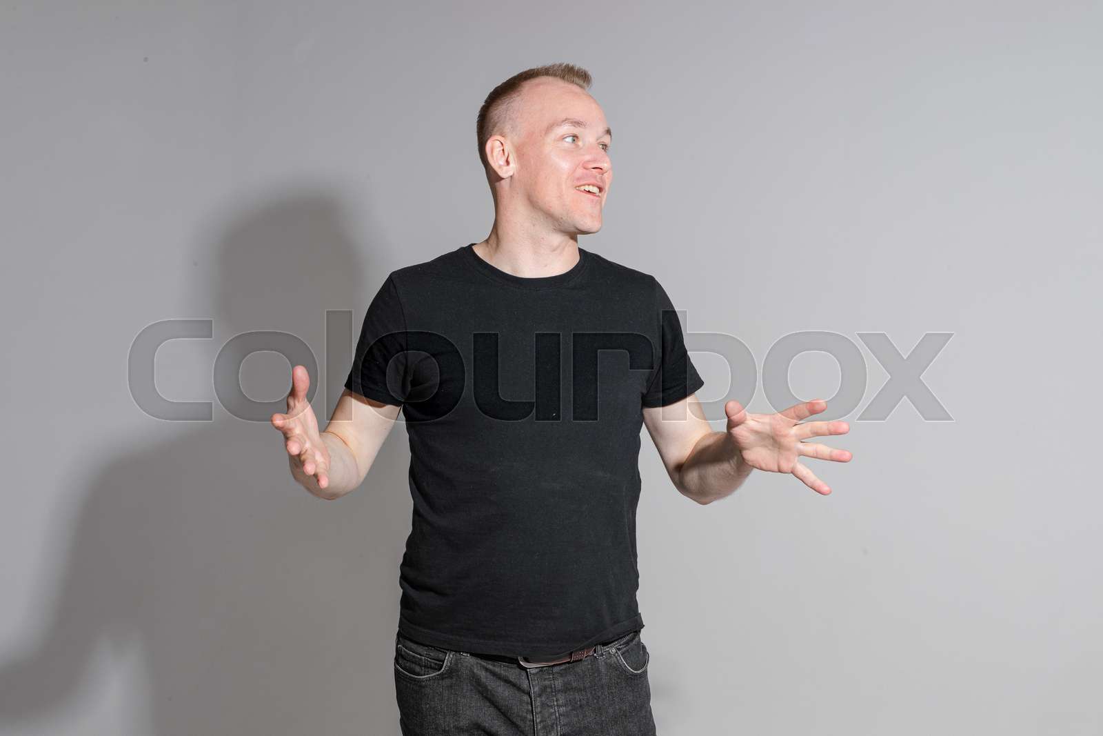 Excited man gesturing and looking away. | Stock image | Colourbox