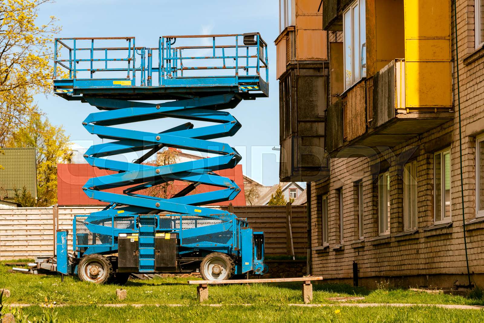 Scissor lift platform for the renovation of the house facade | Stock ...