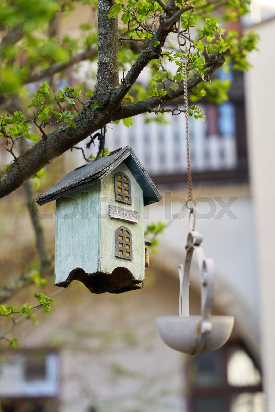 Wooden bird house as decoration in a tree in the garden | Stock image ...
