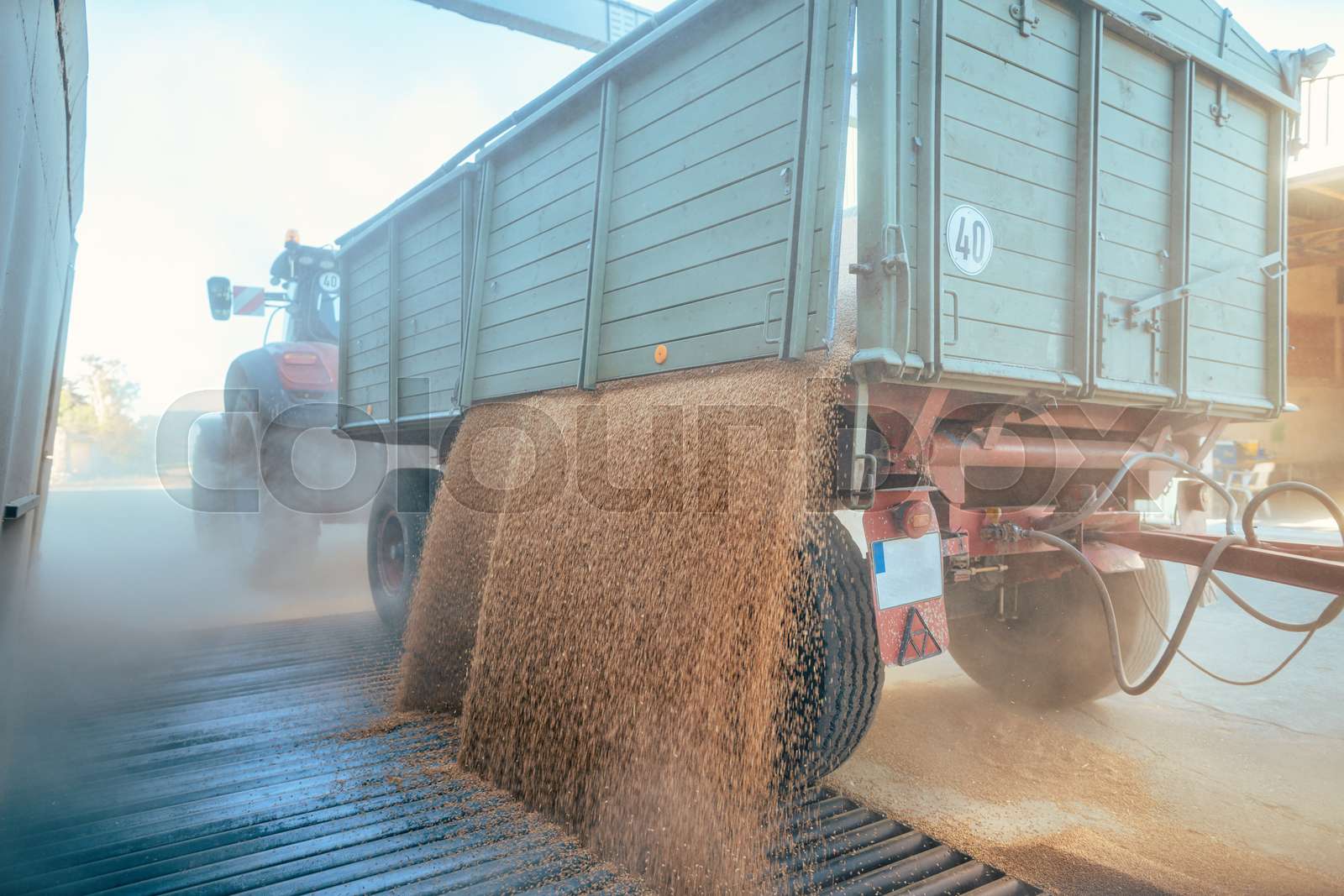 Farmer unloading his grain harvest to the granary | Stock image | Colourbox