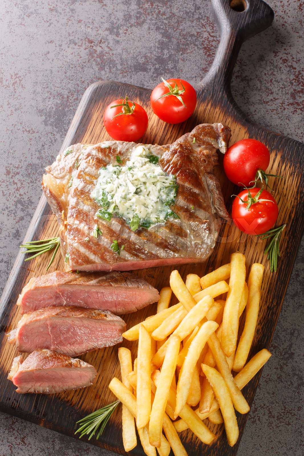 Delicious grilled steak frites with French fries and green butter ...