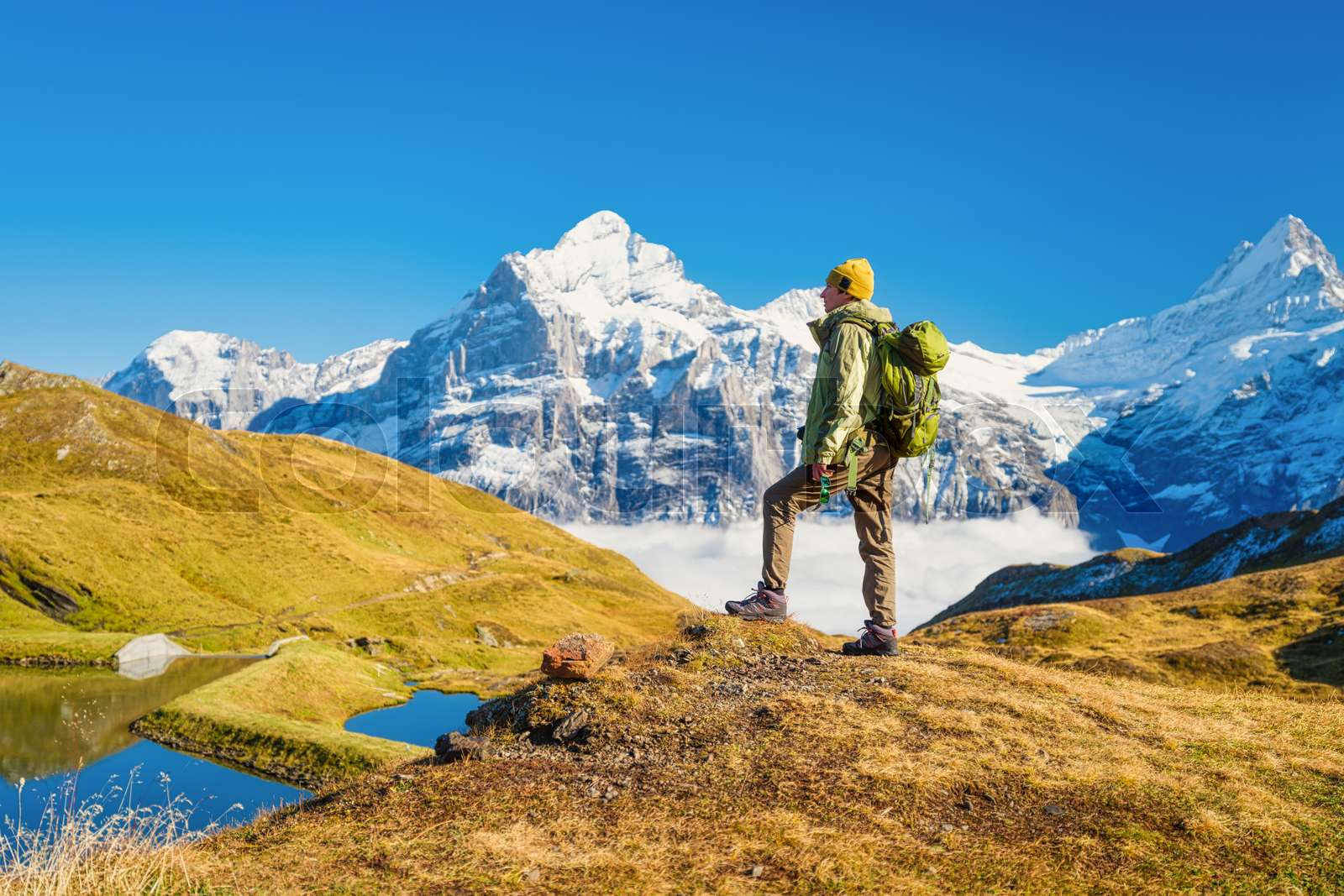 Tourist with a backpack in the mountains. Mountain hiking in the high ...