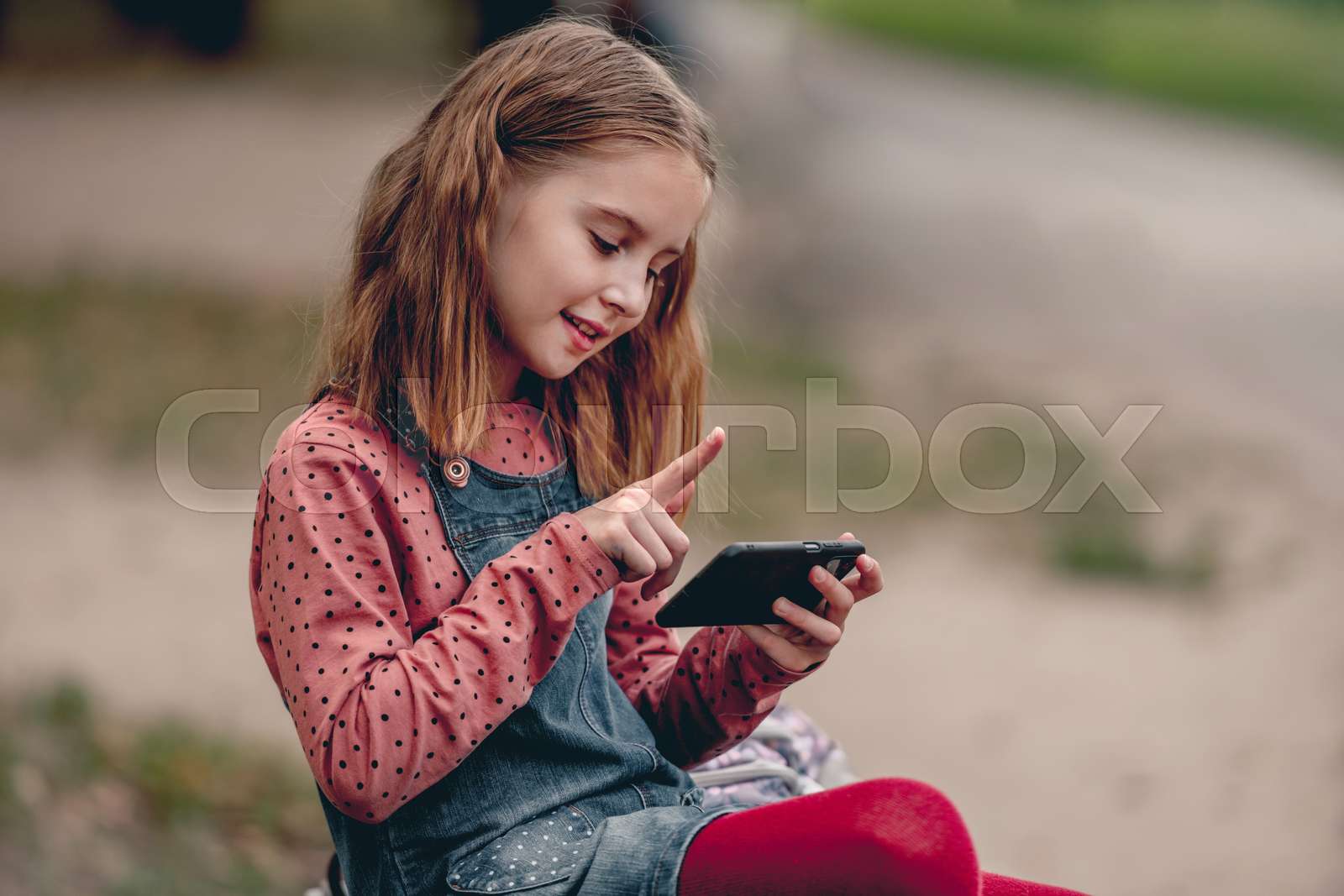 School girl with smartphone | Stock image | Colourbox