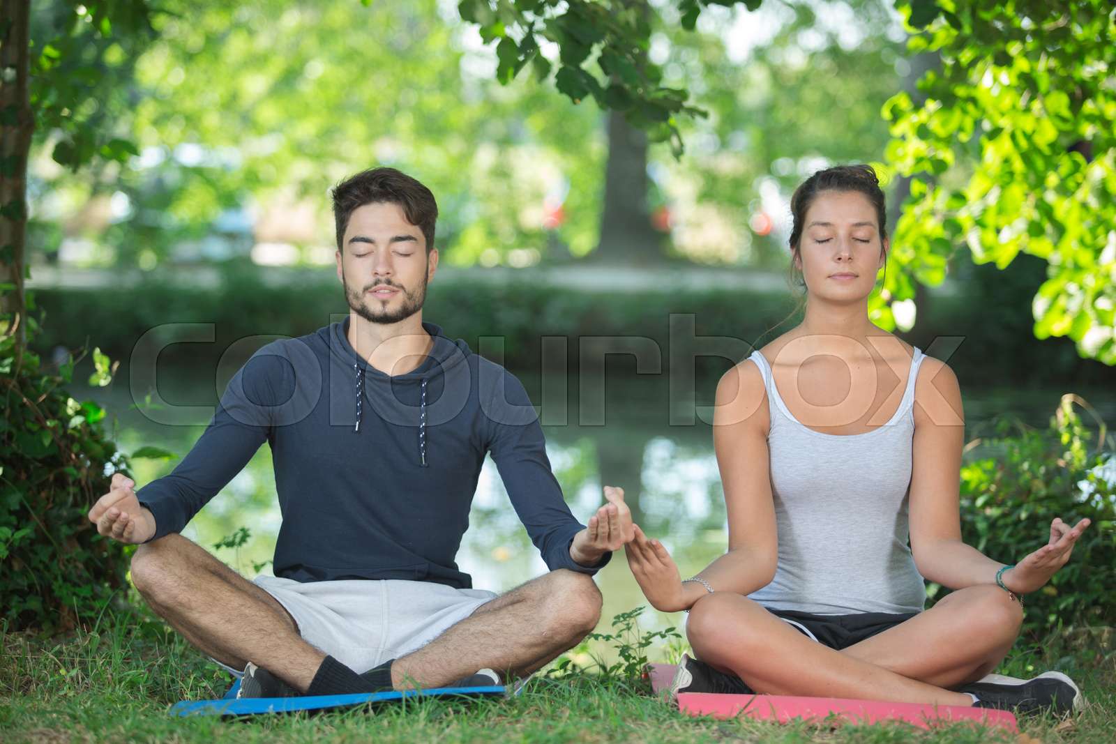 yougn couple practicing yoga in nature | Stock image | Colourbox