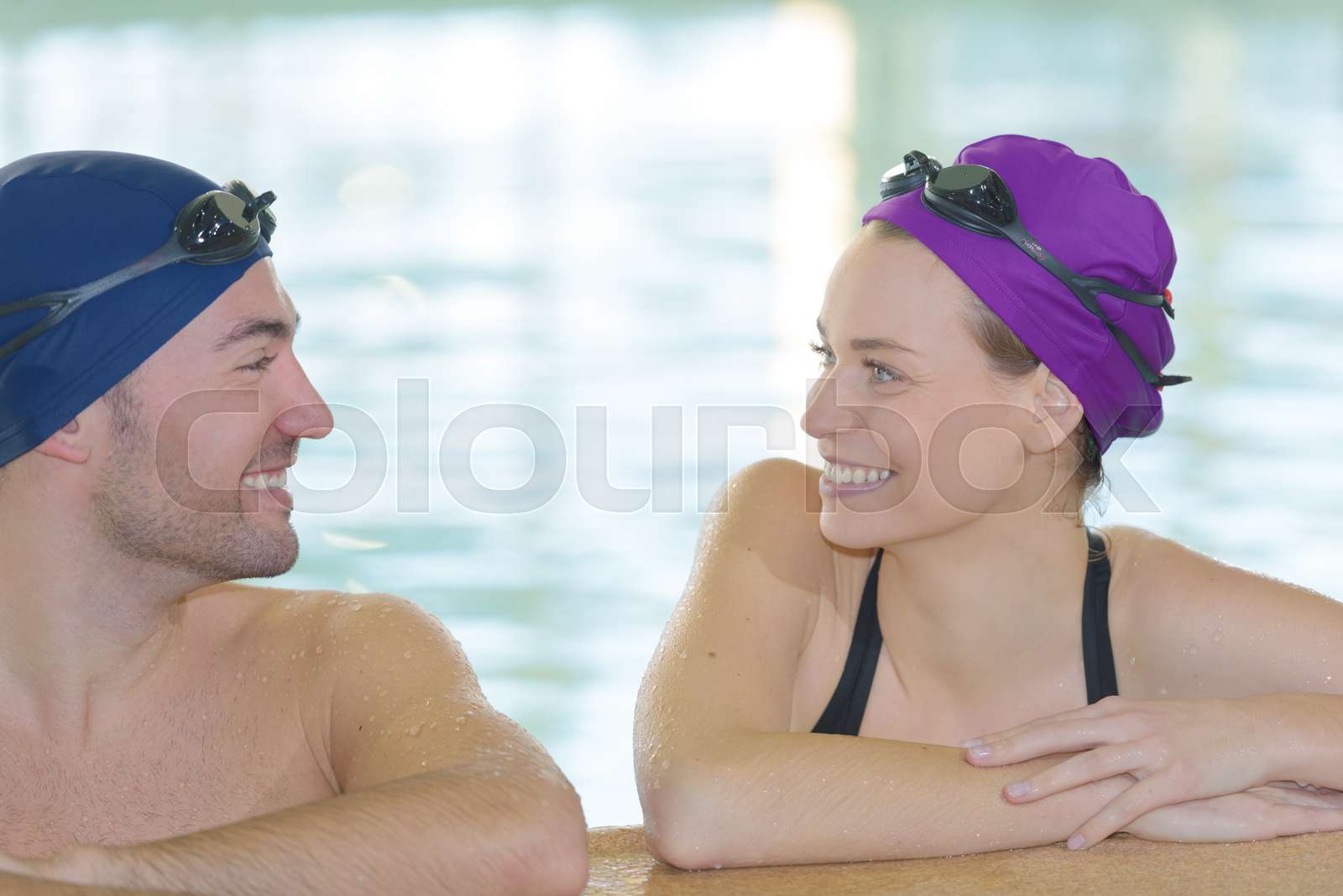 couple having a conversation on the swimming pool | Stock image | Colourbox