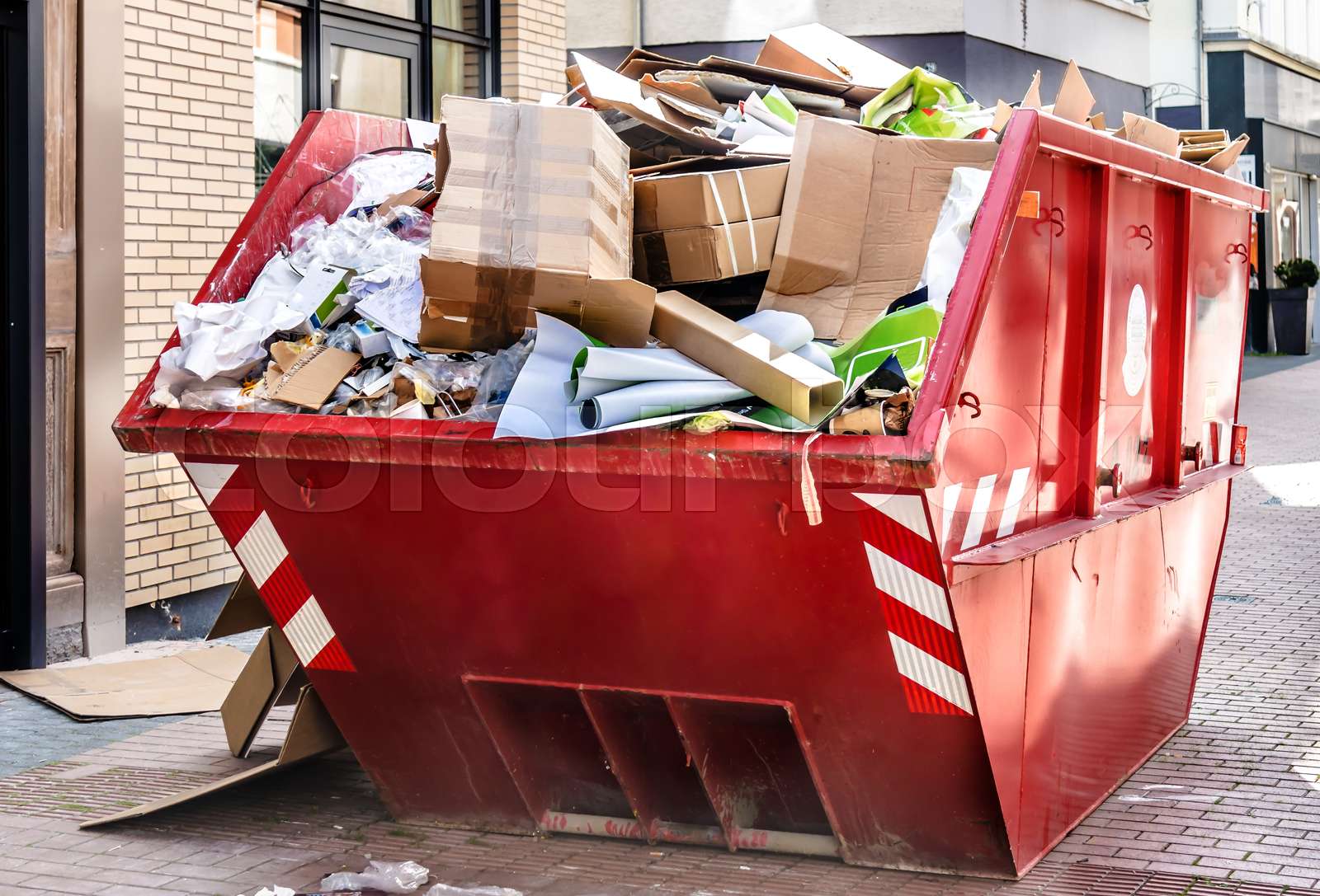 Red Container filled with cardboard Trash | Stock image | Colourbox