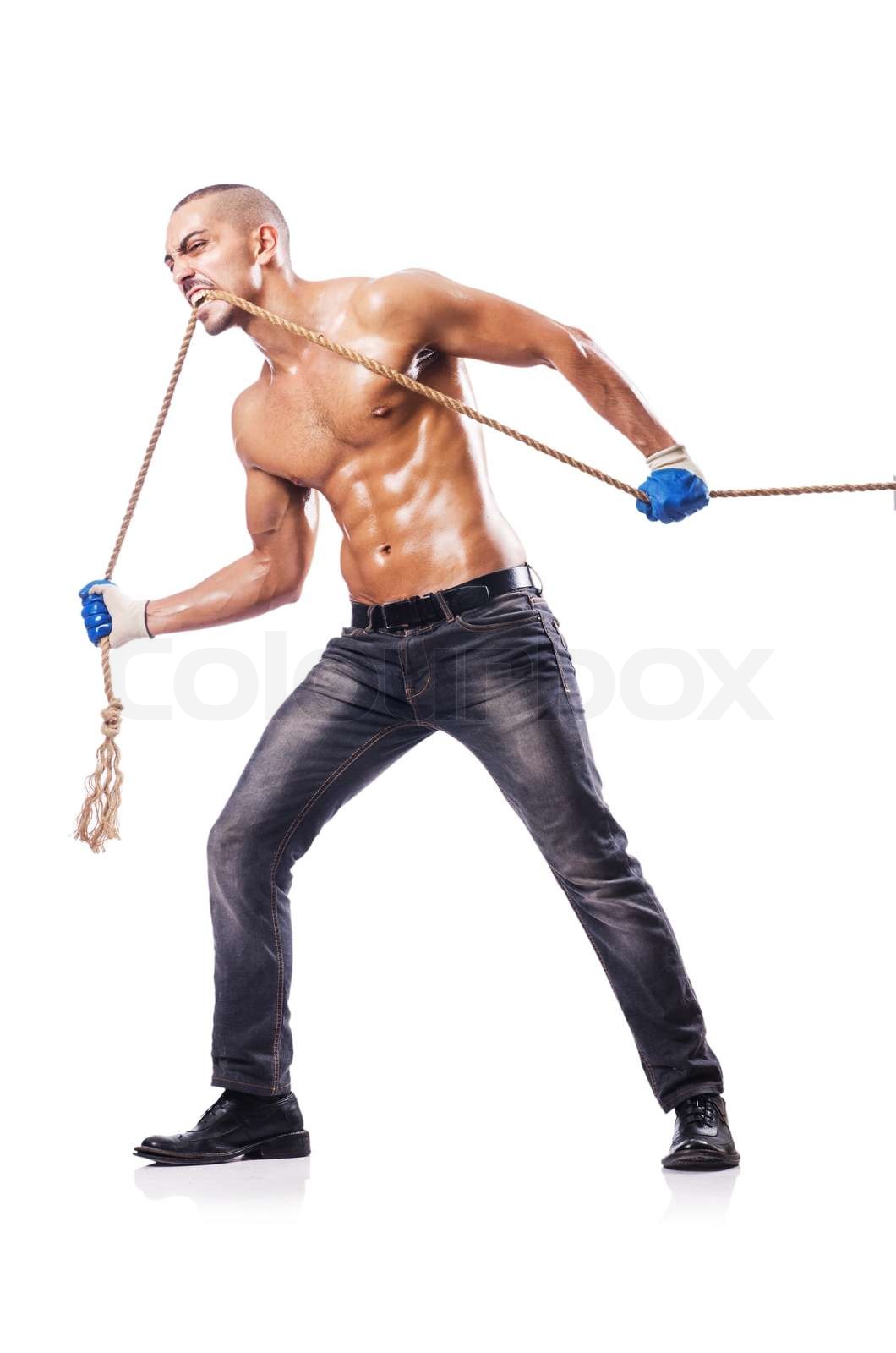 Muscular man pulling the rope | Stock image | Colourbox