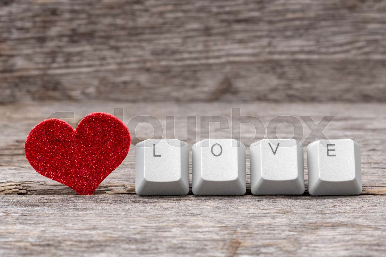 Red heart and word LOVE written on keyboard keys | Stock image | Colourbox