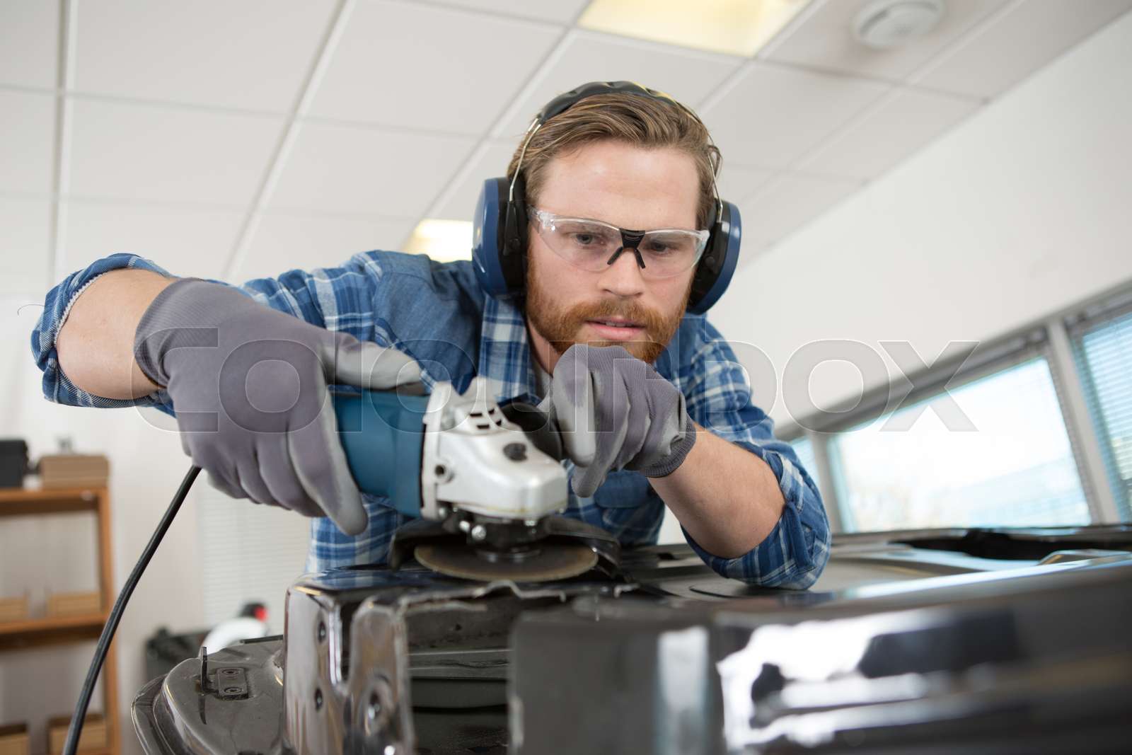 male worker using an angle grinder | Stock image | Colourbox
