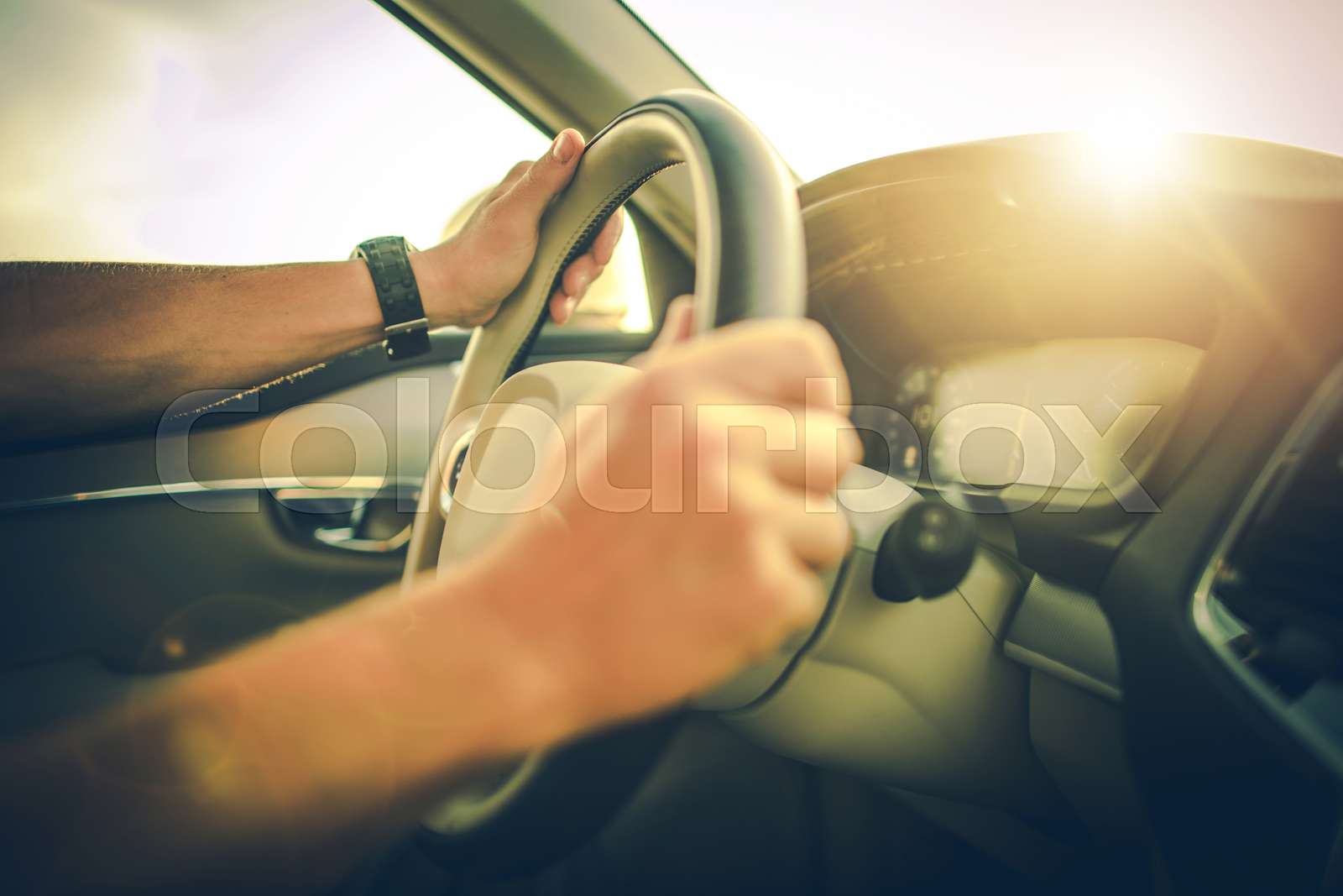 Hands on the Steering Wheel While Driving a Car | Stock image | Colourbox