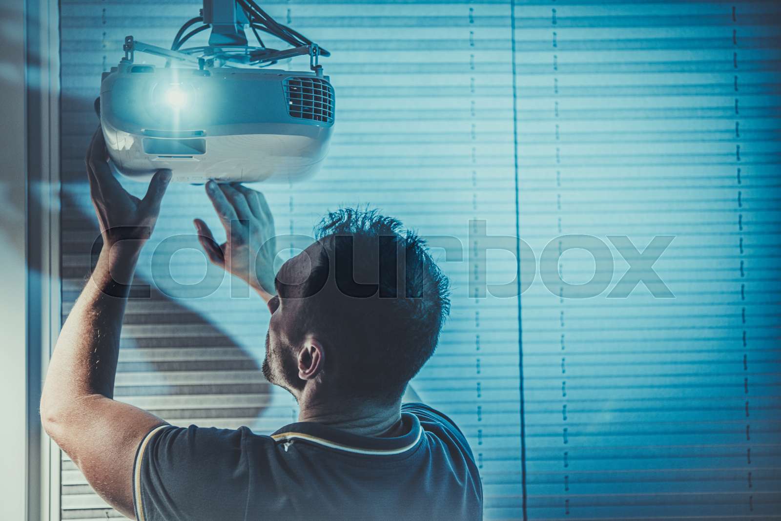 Men Adjusting Home Multimedia Projector | Stock image | Colourbox