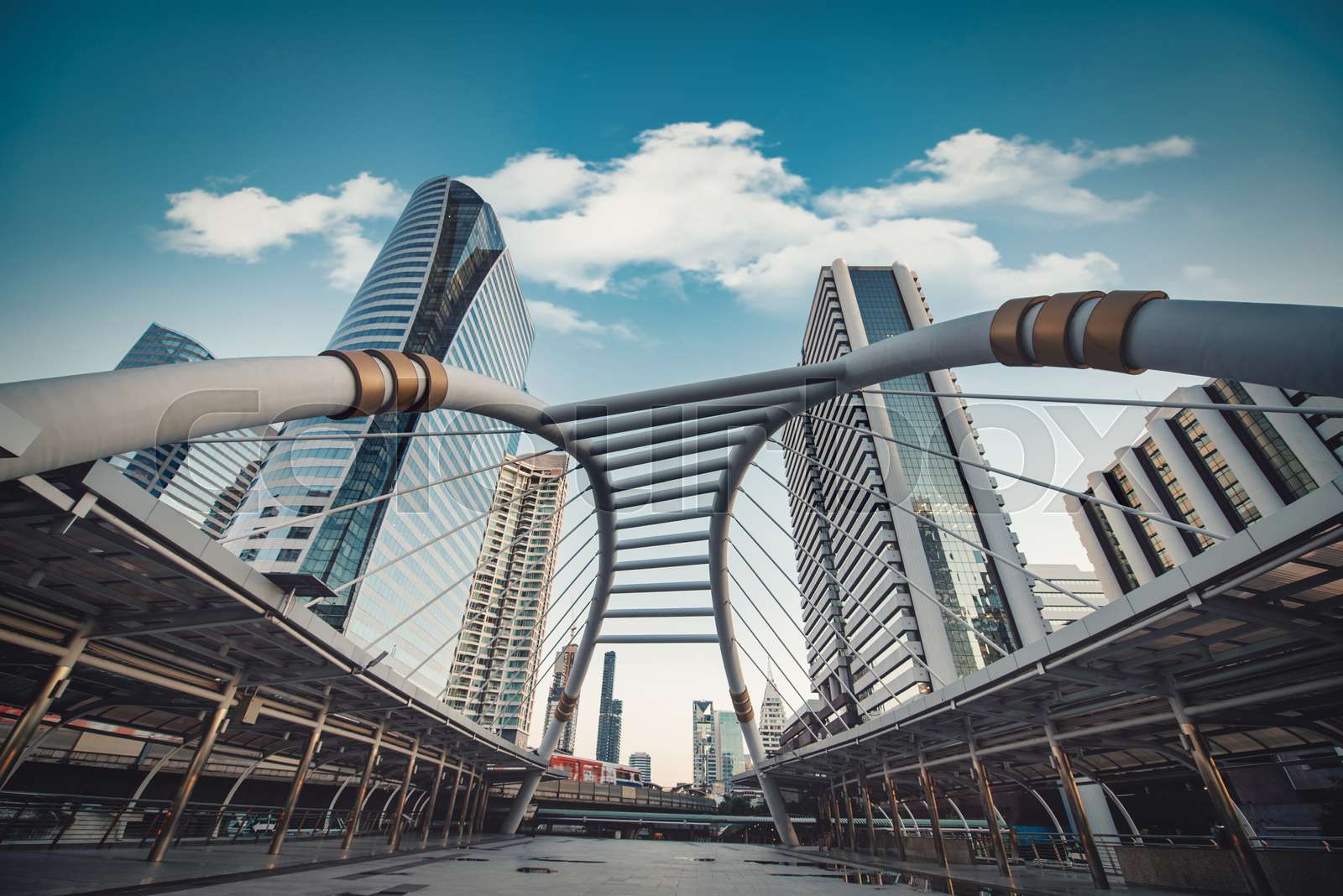 Modern structure bridge shape and building at sunset in train station ...