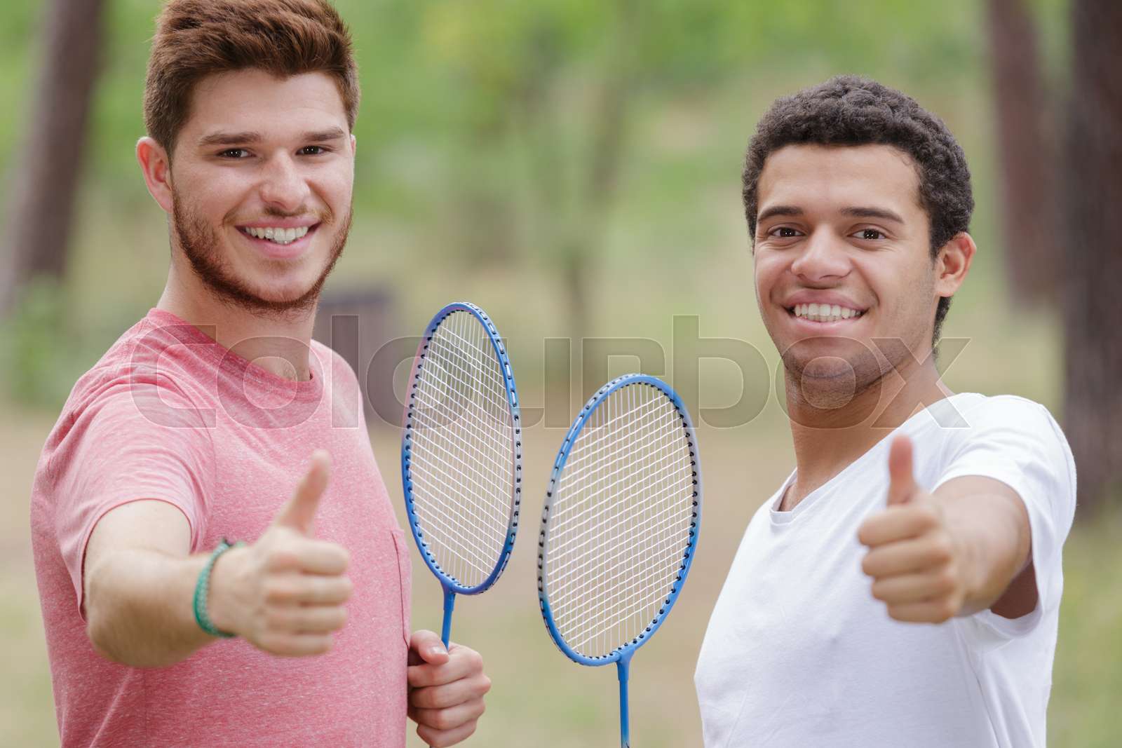 portrait of two male badminton players showing thumbs up | Stock image ...