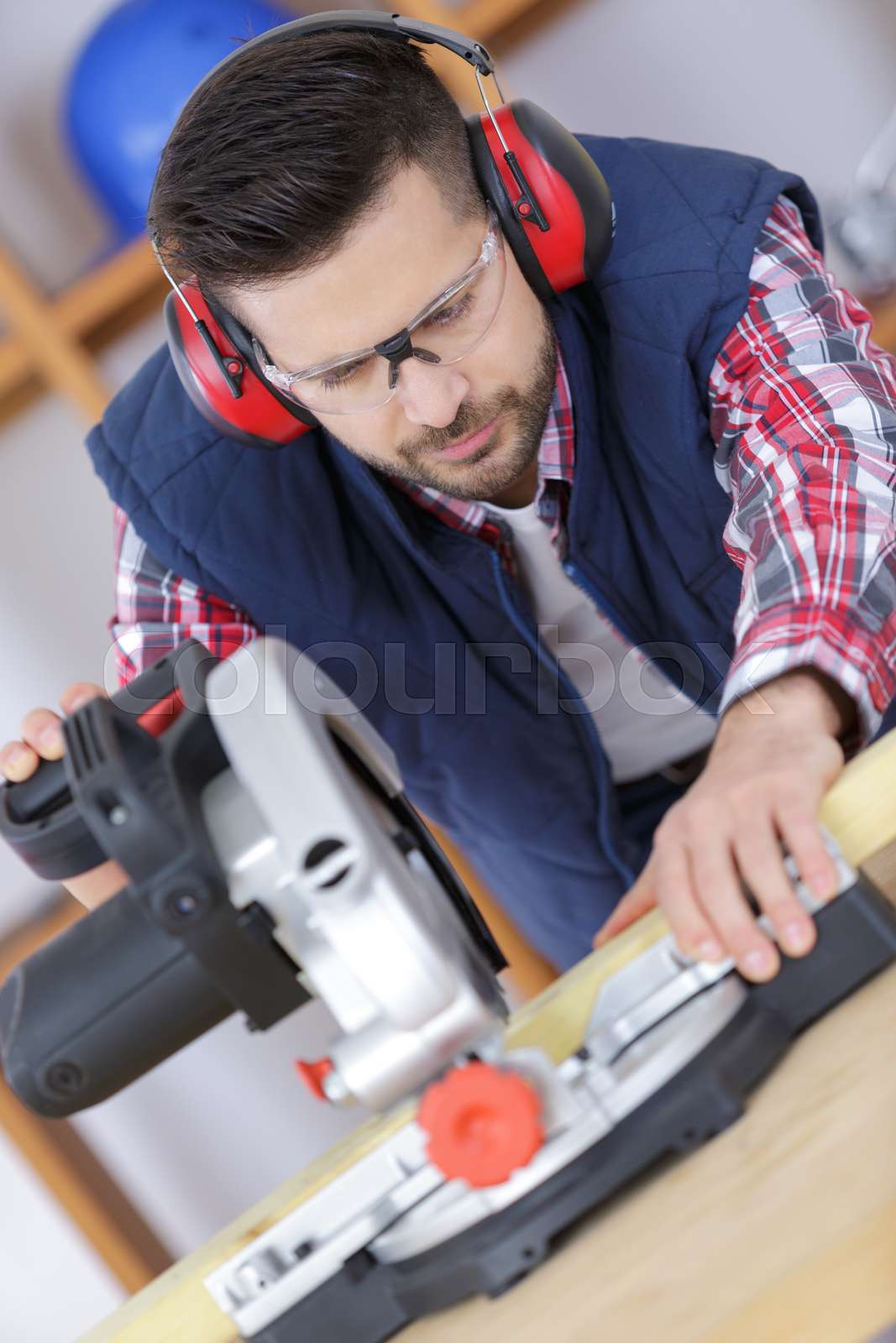 carpenter cutting flaxboard using sliding compound mitre saw | Stock ...