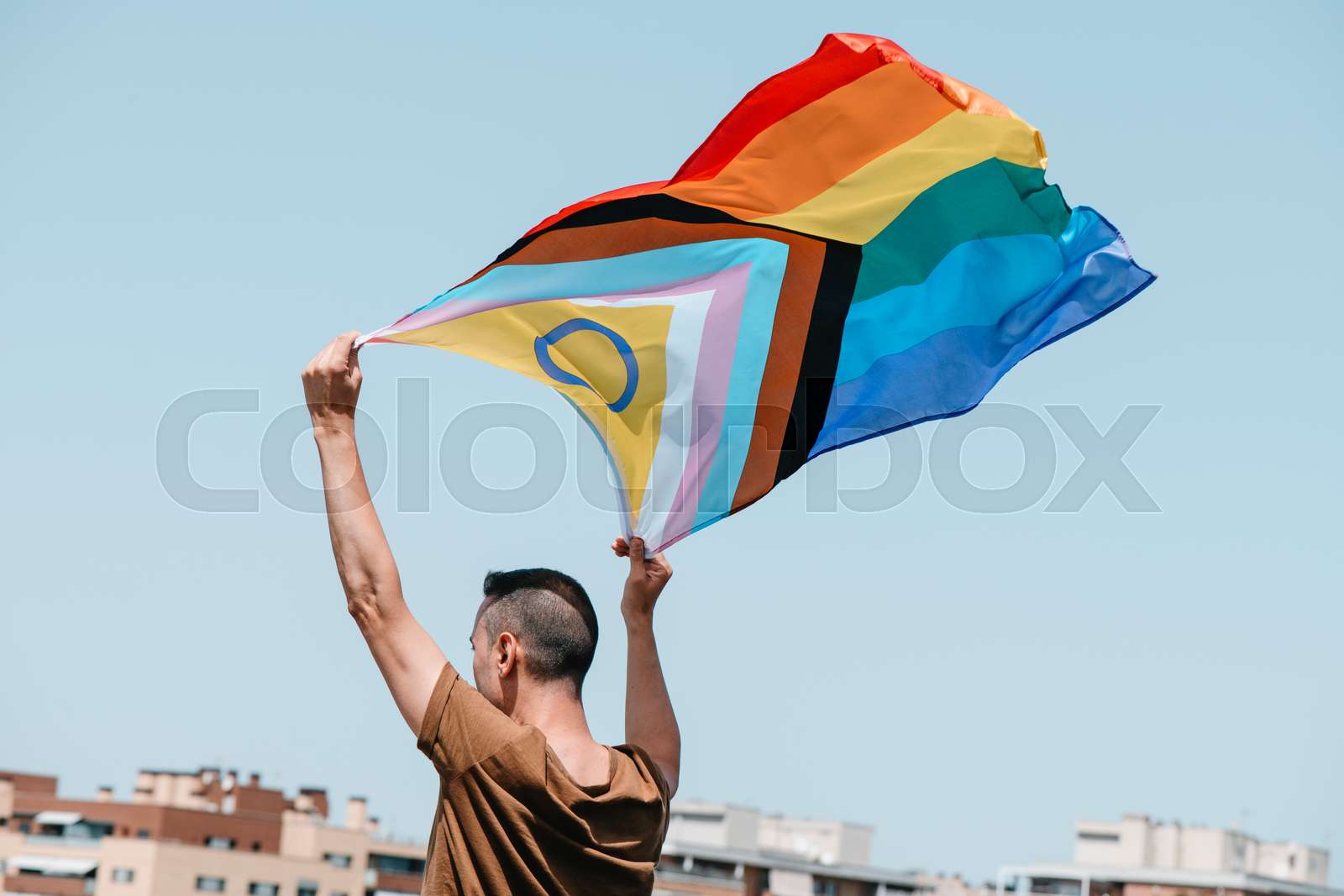 waves a progress pride flag in the air | Stock image | Colourbox