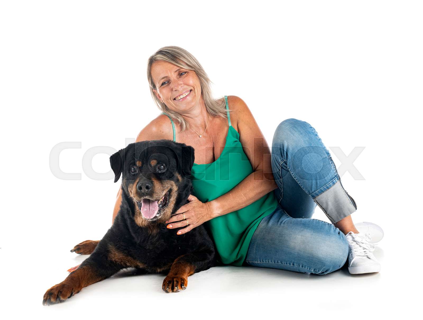 old rottweiler and owner in studio | Stock image | Colourbox
