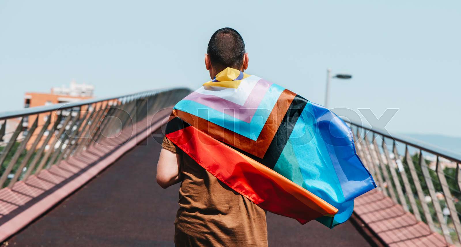 man wrapped in a progress pride flag, web banner | Stock image | Colourbox
