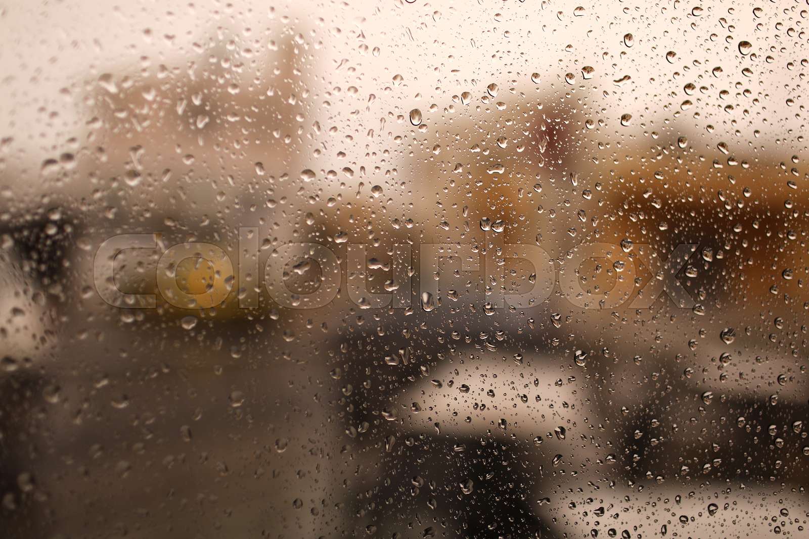 Rainy city background. Raindrops on window glass on autumn day. Wet ...