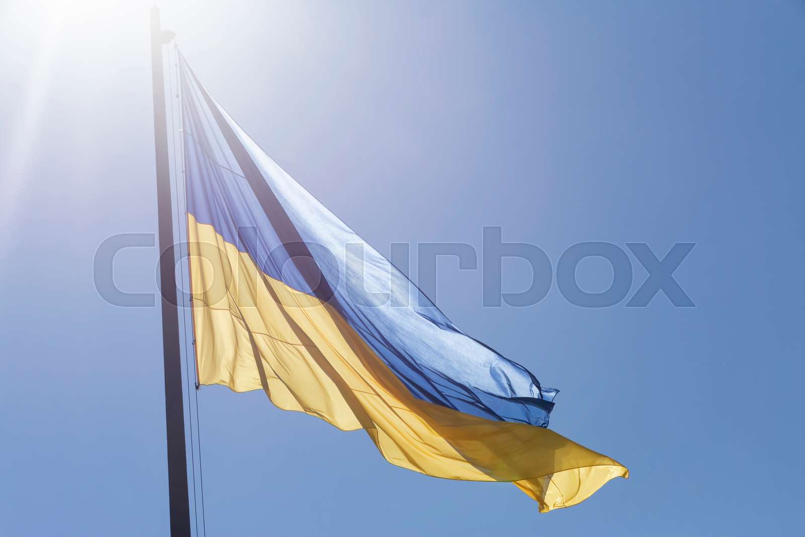 Ukrainian flag on flagpole at sunlight | Stock image | Colourbox