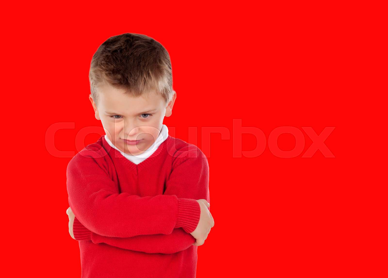 Angry blond child with red jersey | Stock image | Colourbox
