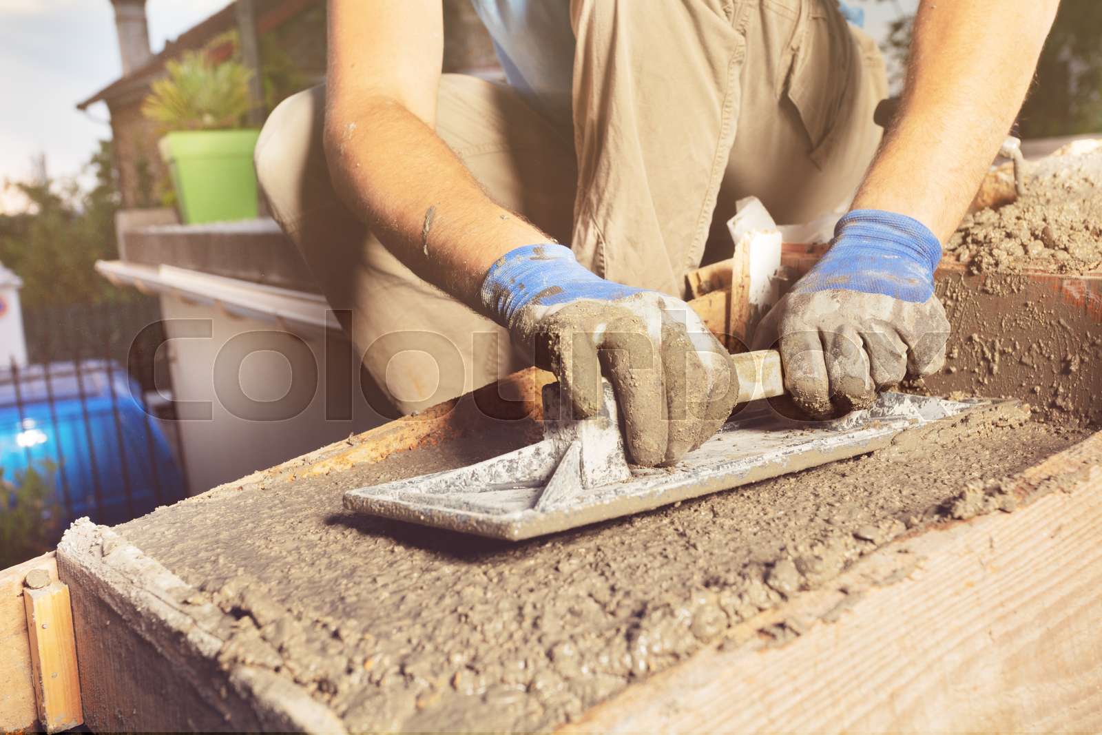 Close-up of a man with trowel make concrete staircase at home | Stock ...