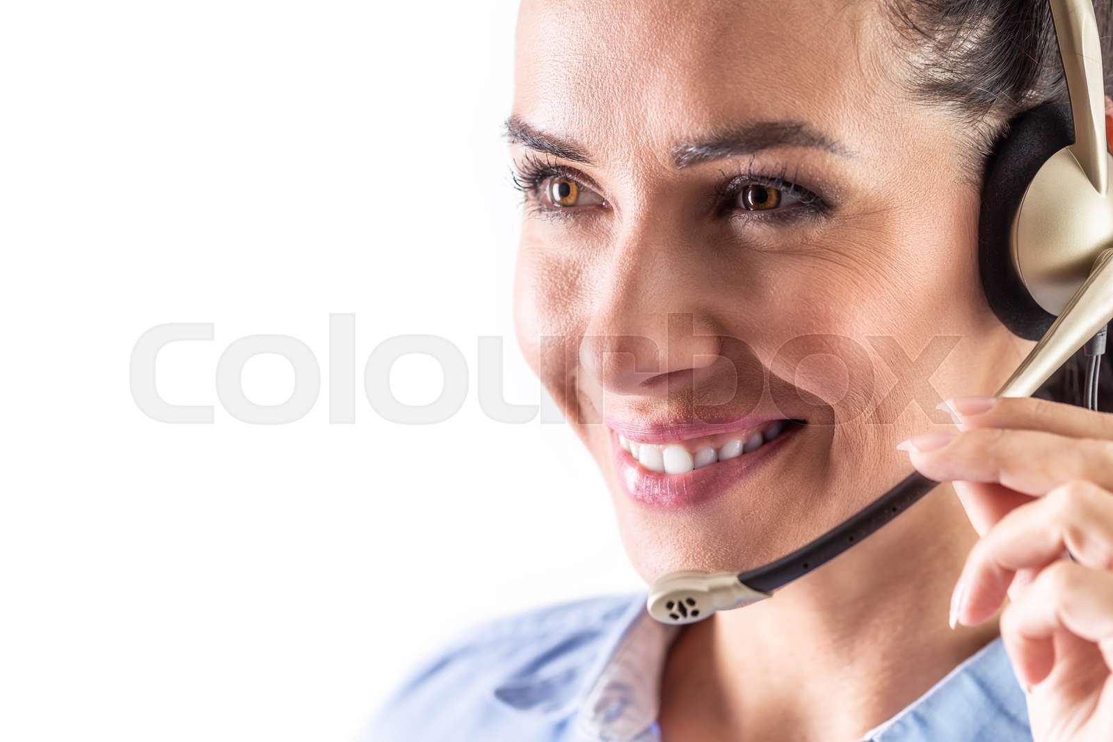 Hotline or call center worker smiling as she responds to a call to a ...