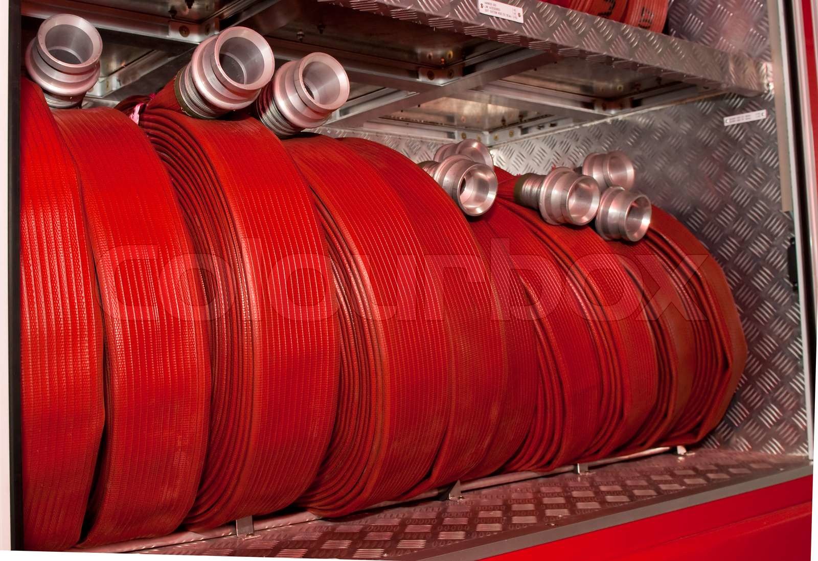 Delivery hosein the shelves on fire engine compartment | Stock image ...