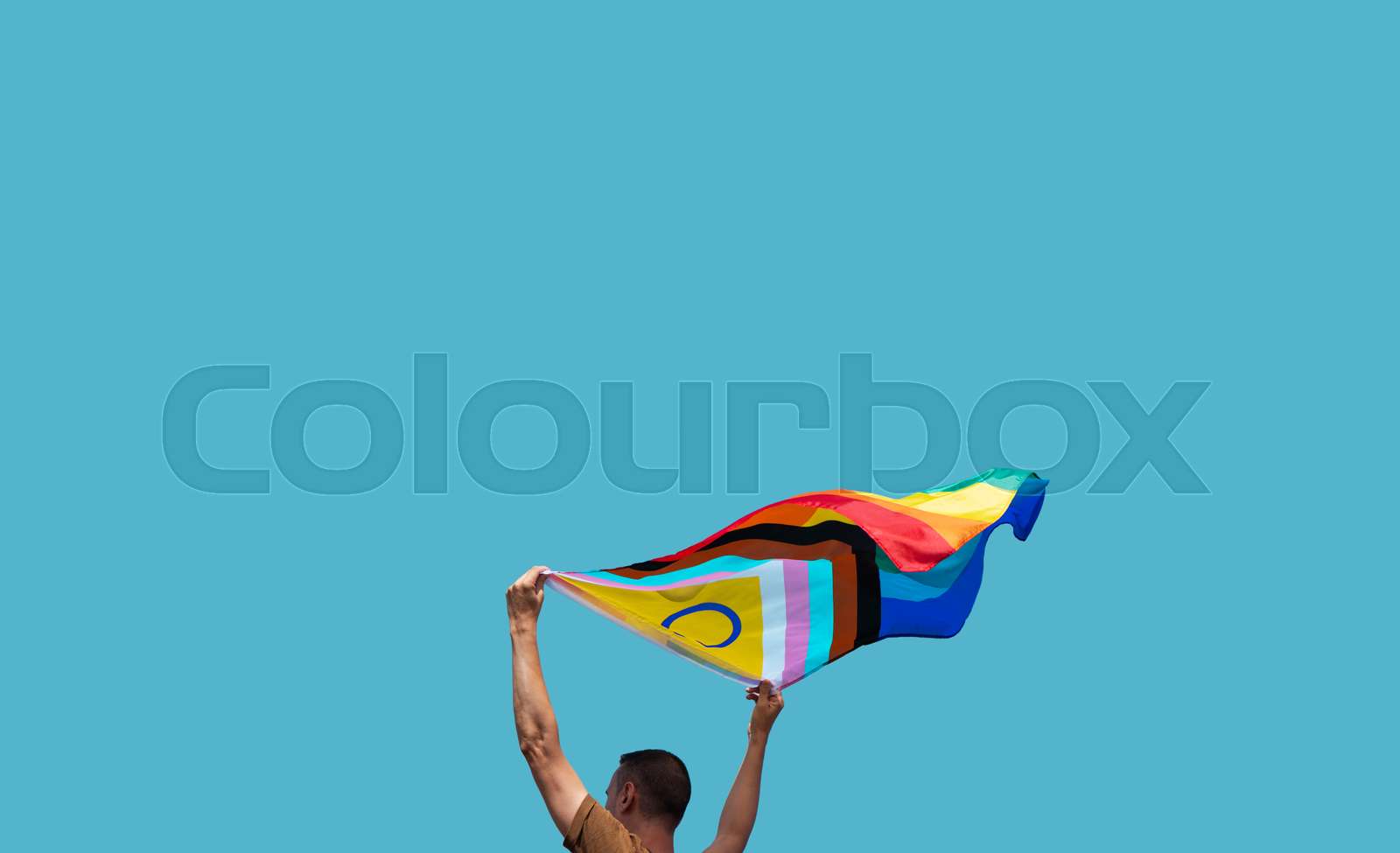man is waving a progress pride flag outdoors | Stock image | Colourbox