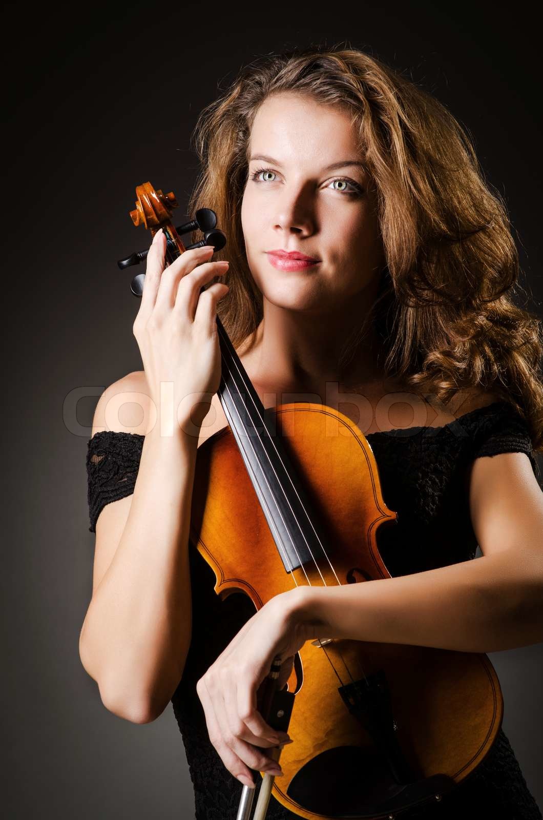Woman performer with violin in studio | Stock image | Colourbox