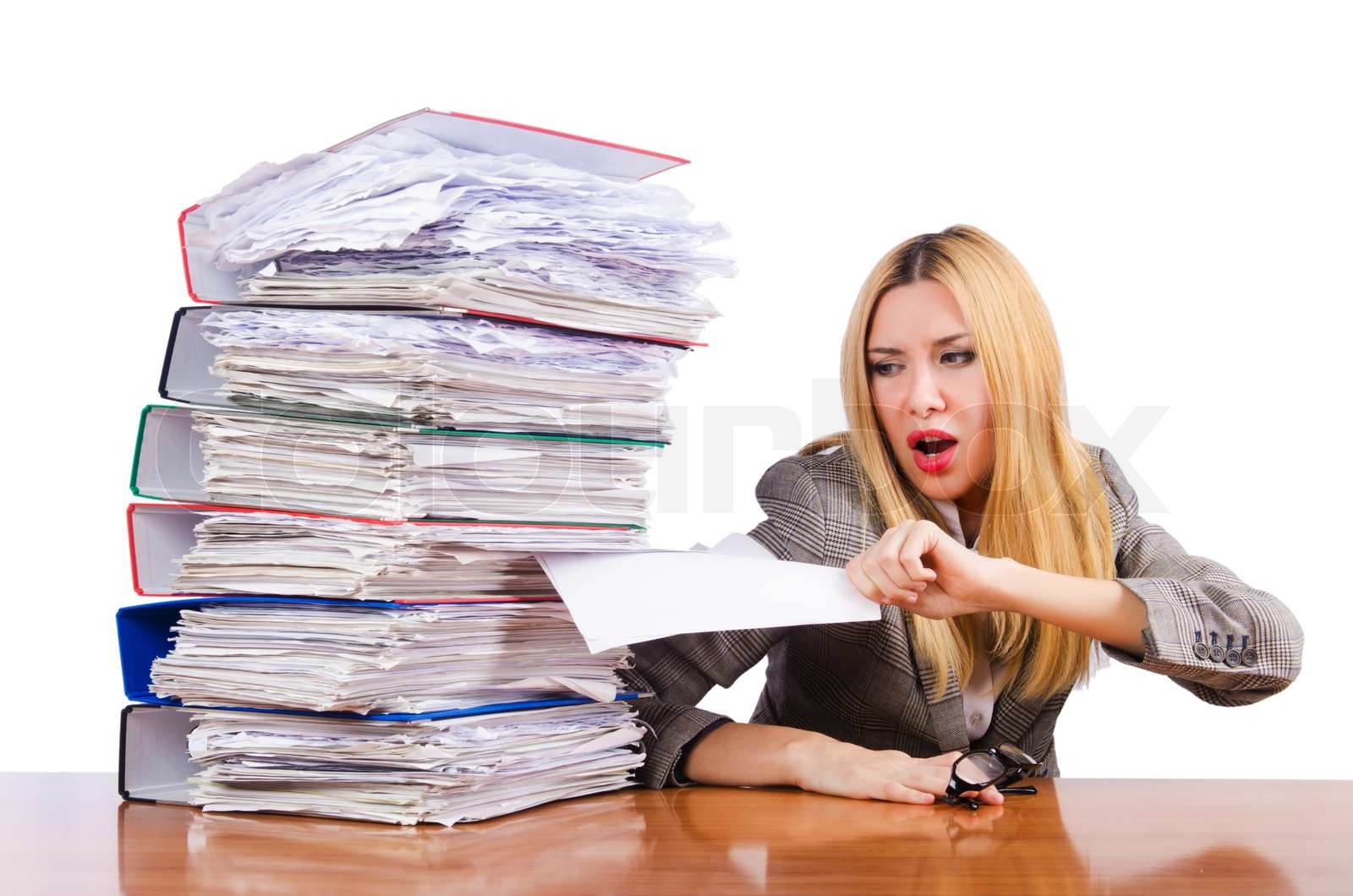 Busy woman with stacks of paper | Stock image | Colourbox
