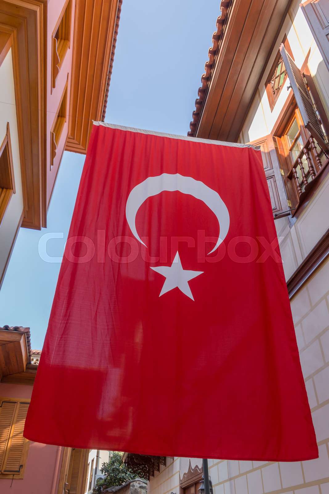 Turkish flag hanging between buildings in Antalya | Stock image | Colourbox