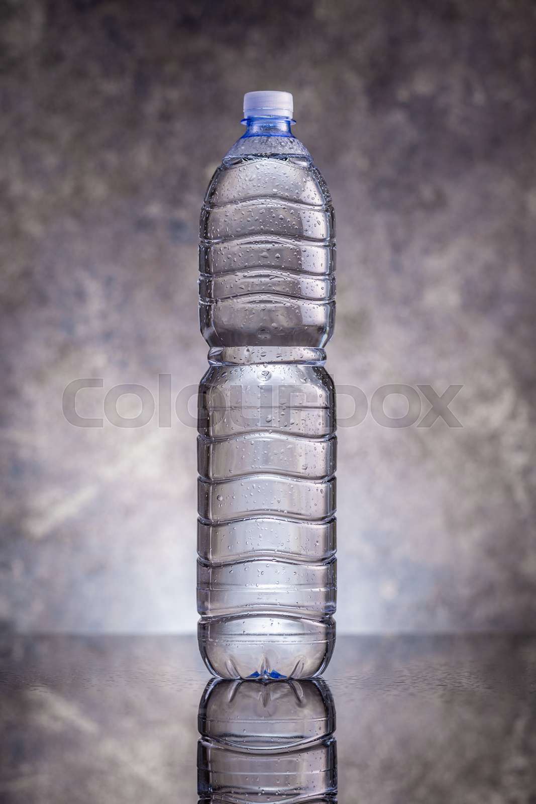 Plastic cold bottle of water with water drops. | Stock image | Colourbox