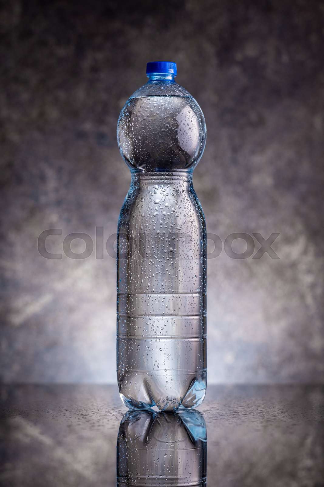 Plastic cold bottle of water with water drops. | Stock image | Colourbox