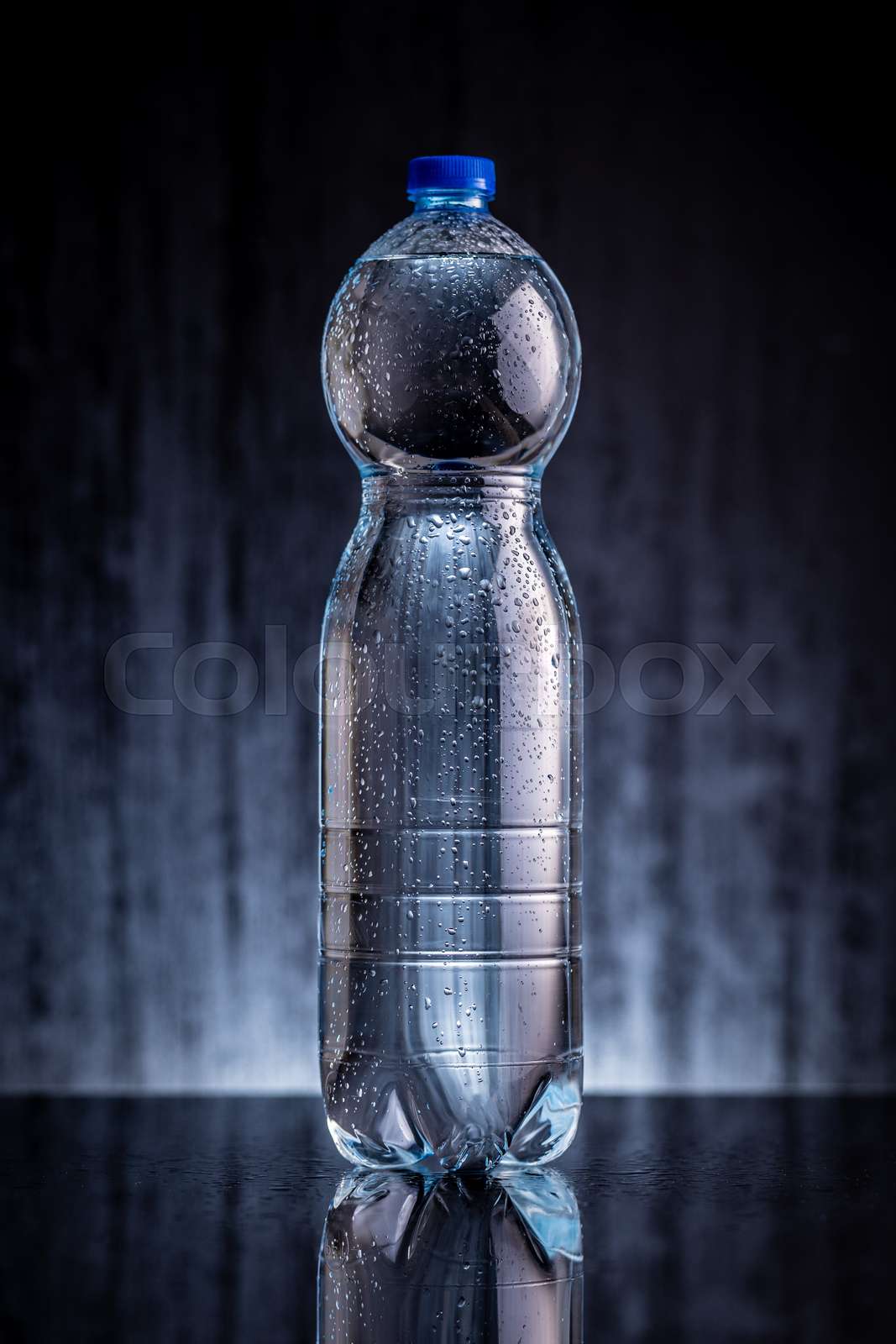 Plastic cold bottle of water with water drops. | Stock image | Colourbox