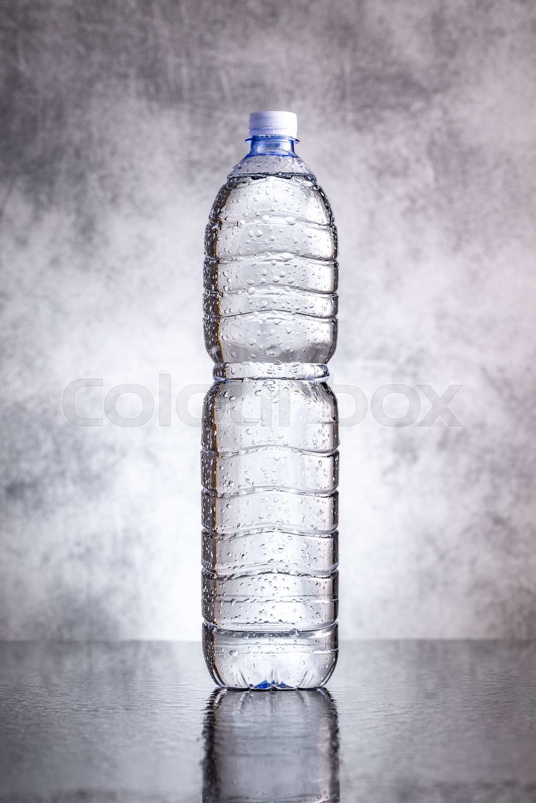 Plastic cold bottle of water with water drops. | Stock image | Colourbox
