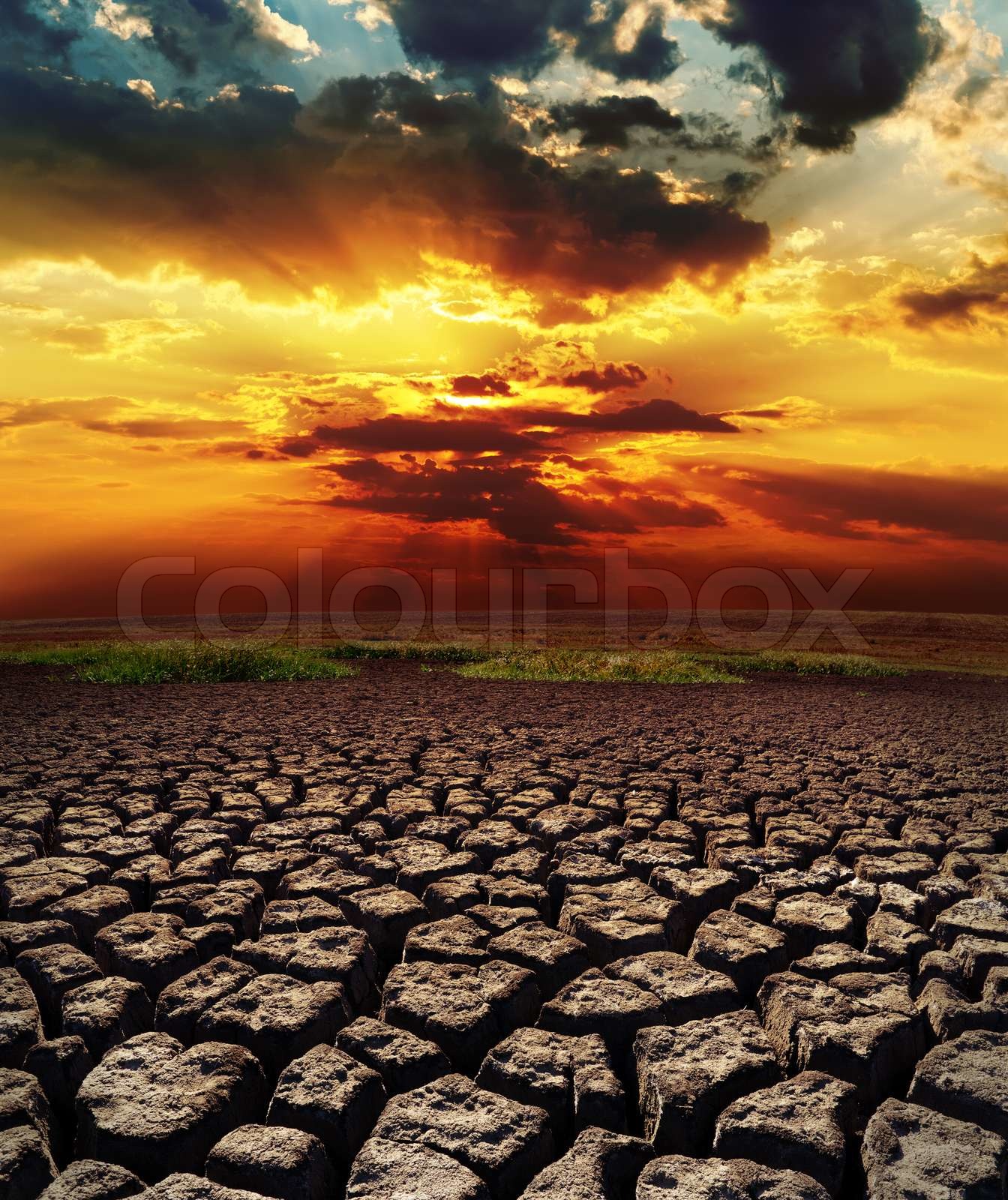 dramatic sunset over drought land | Stock image | Colourbox