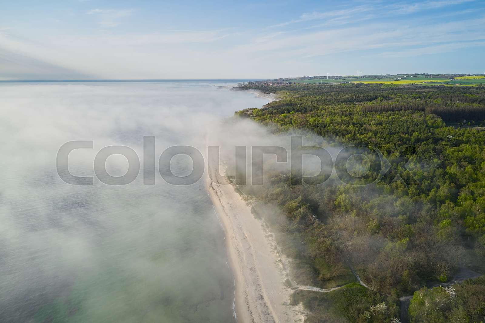 fog over the ocean hitting the shore in denmark | Stock image | Colourbox