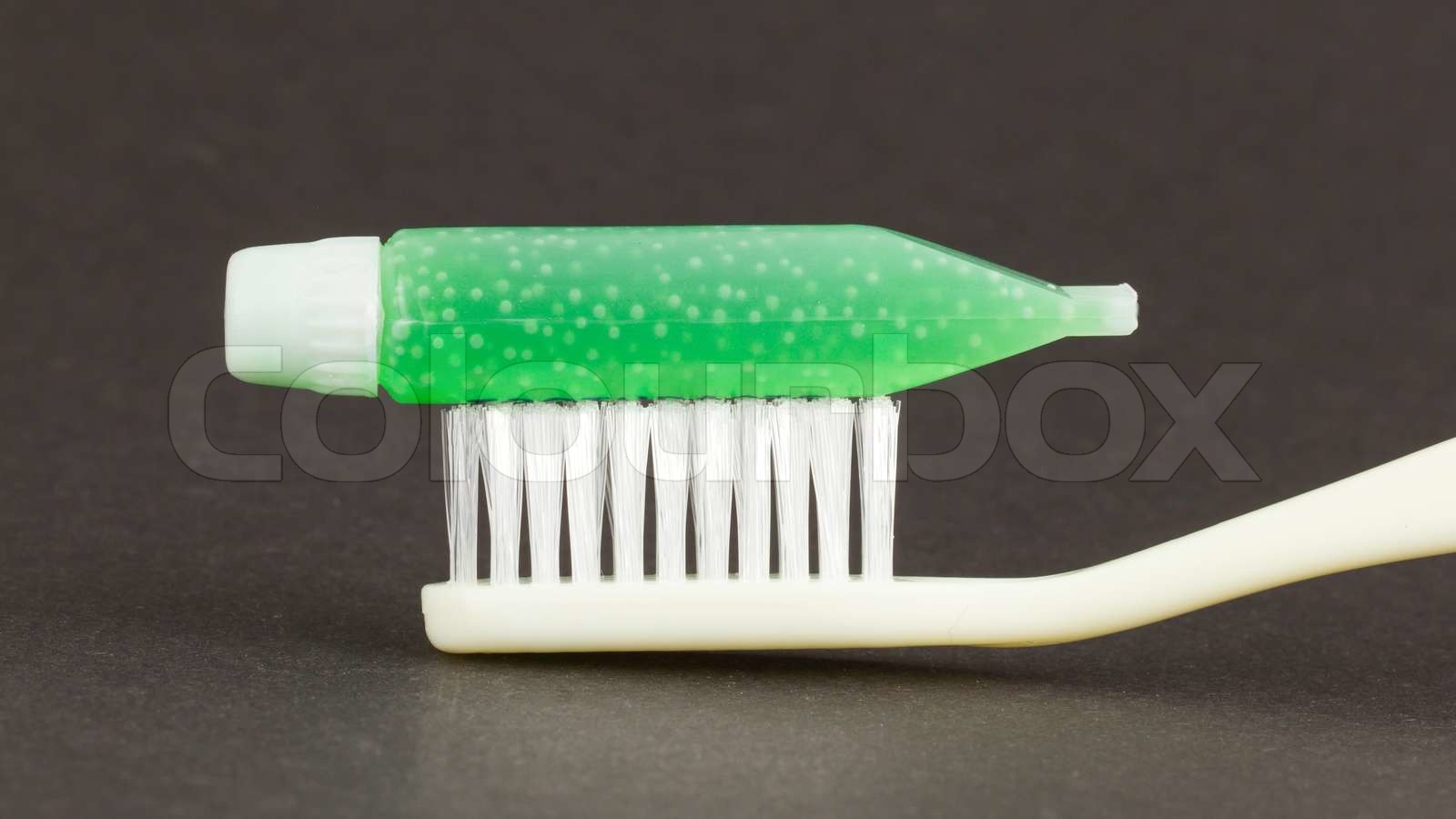 Toothbrush and green toothpaste isolated | Stock image | Colourbox