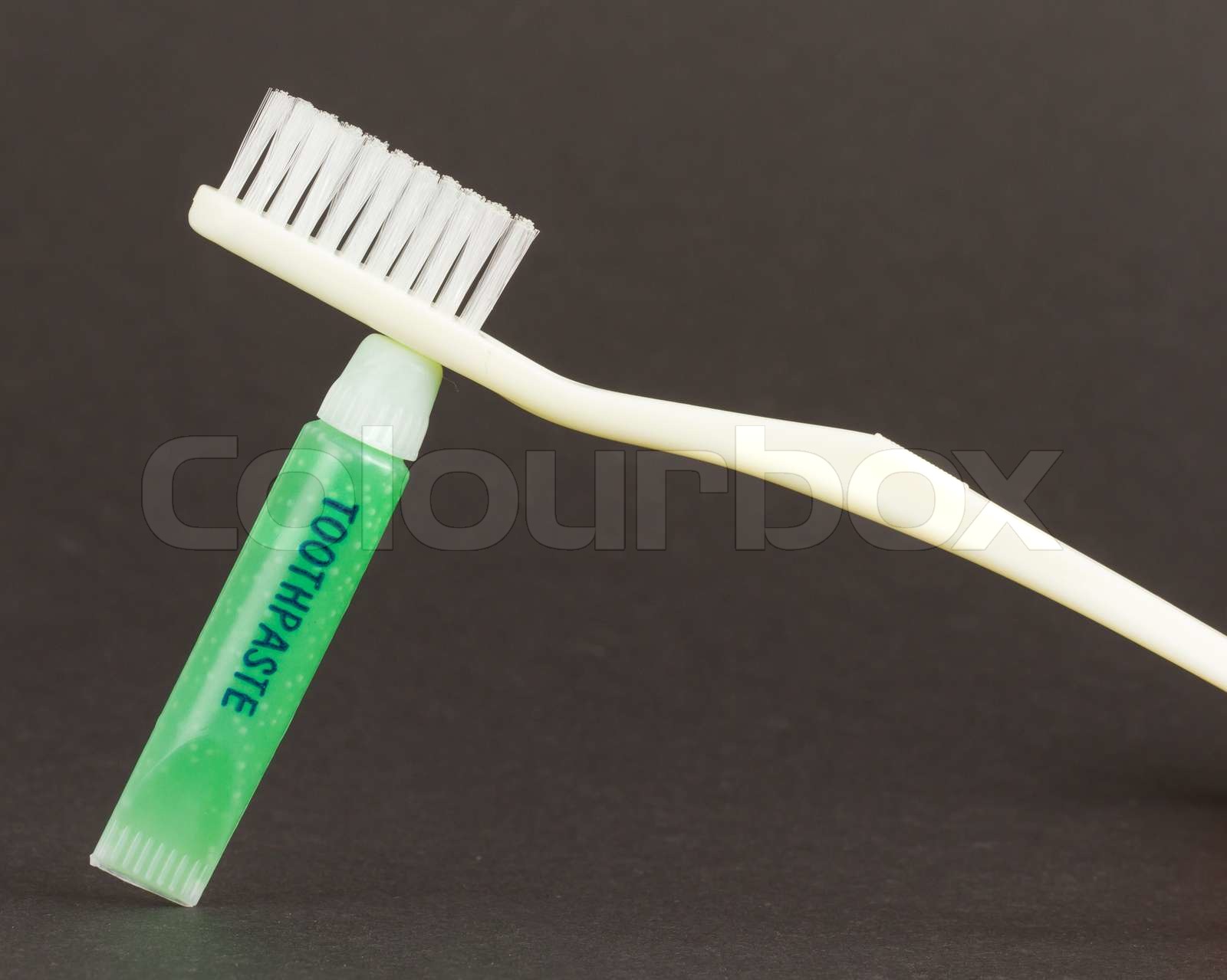 Toothbrush and green toothpaste isolated | Stock image | Colourbox