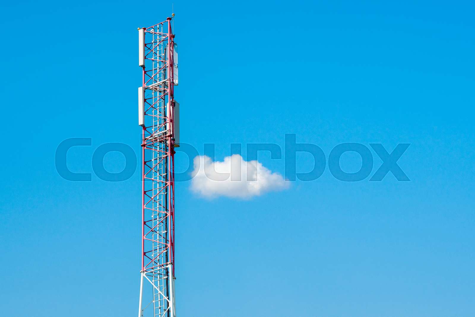 Telecommunication tower with blue sky and single white cloud | Stock ...