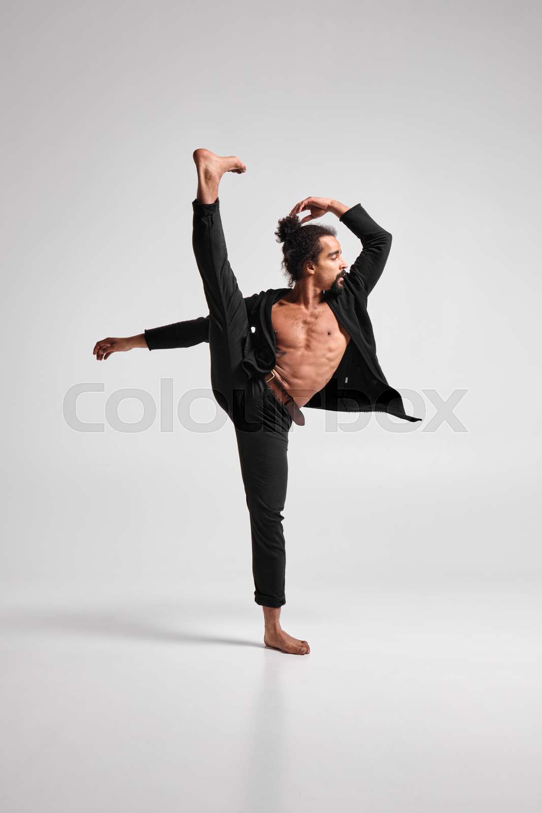 Handsome sporty black guy dancing in studio. | Stock image | Colourbox