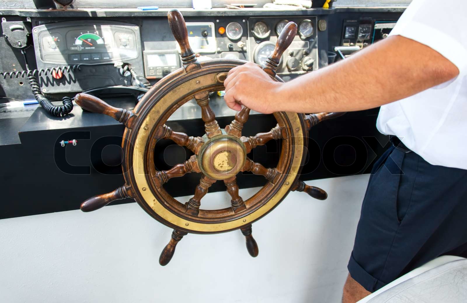 Capitan hand steering a boat | Stock image | Colourbox