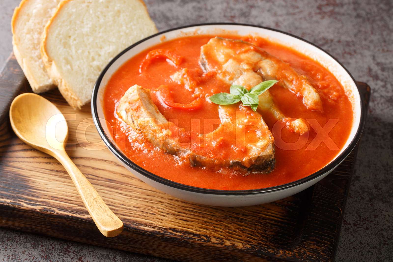 Fishermans soup or halaszle is a hot, spicy paprika based fish soup closeup in the bowl ...