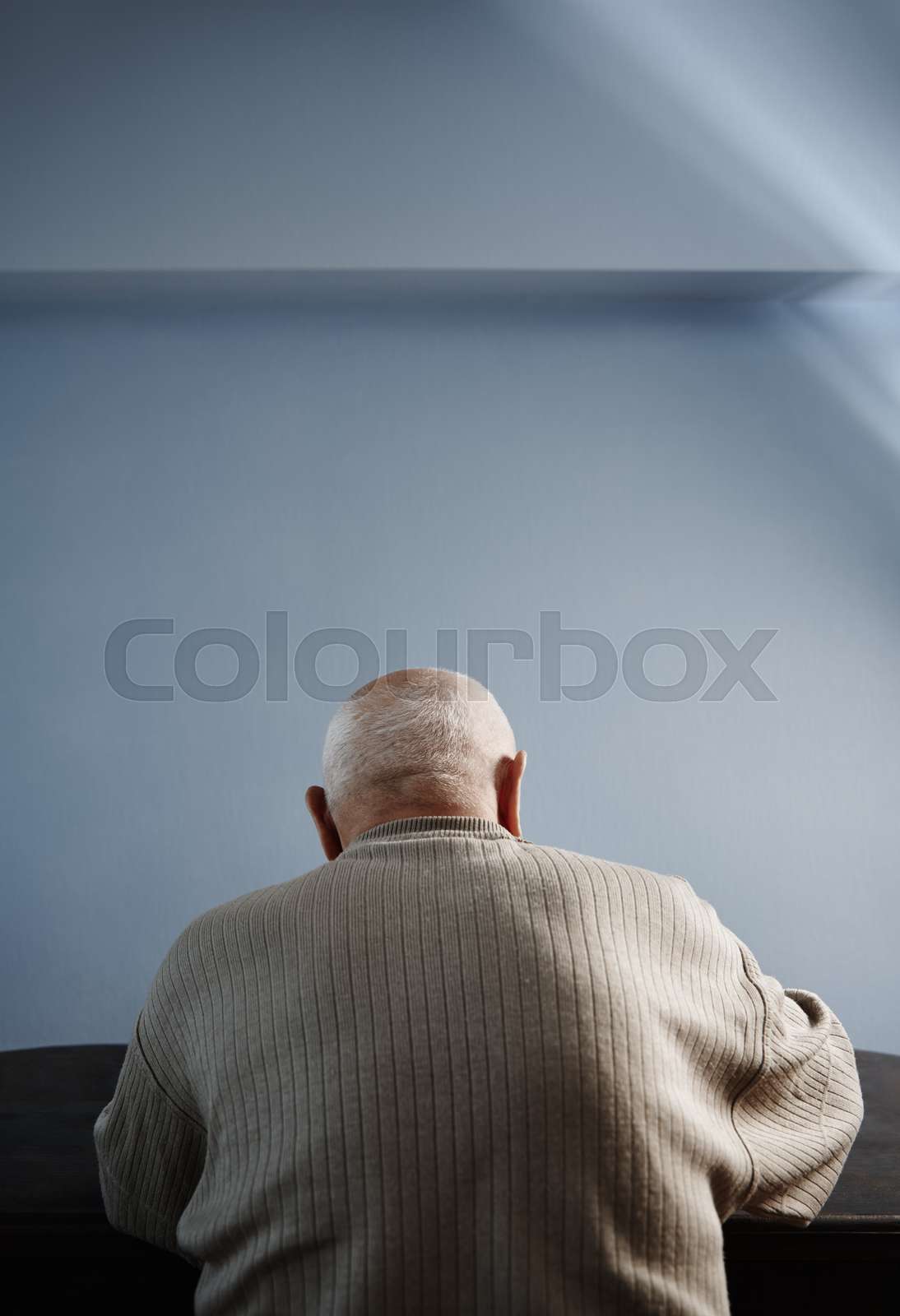 Back view on senior man sitting at the table | Stock image | Colourbox