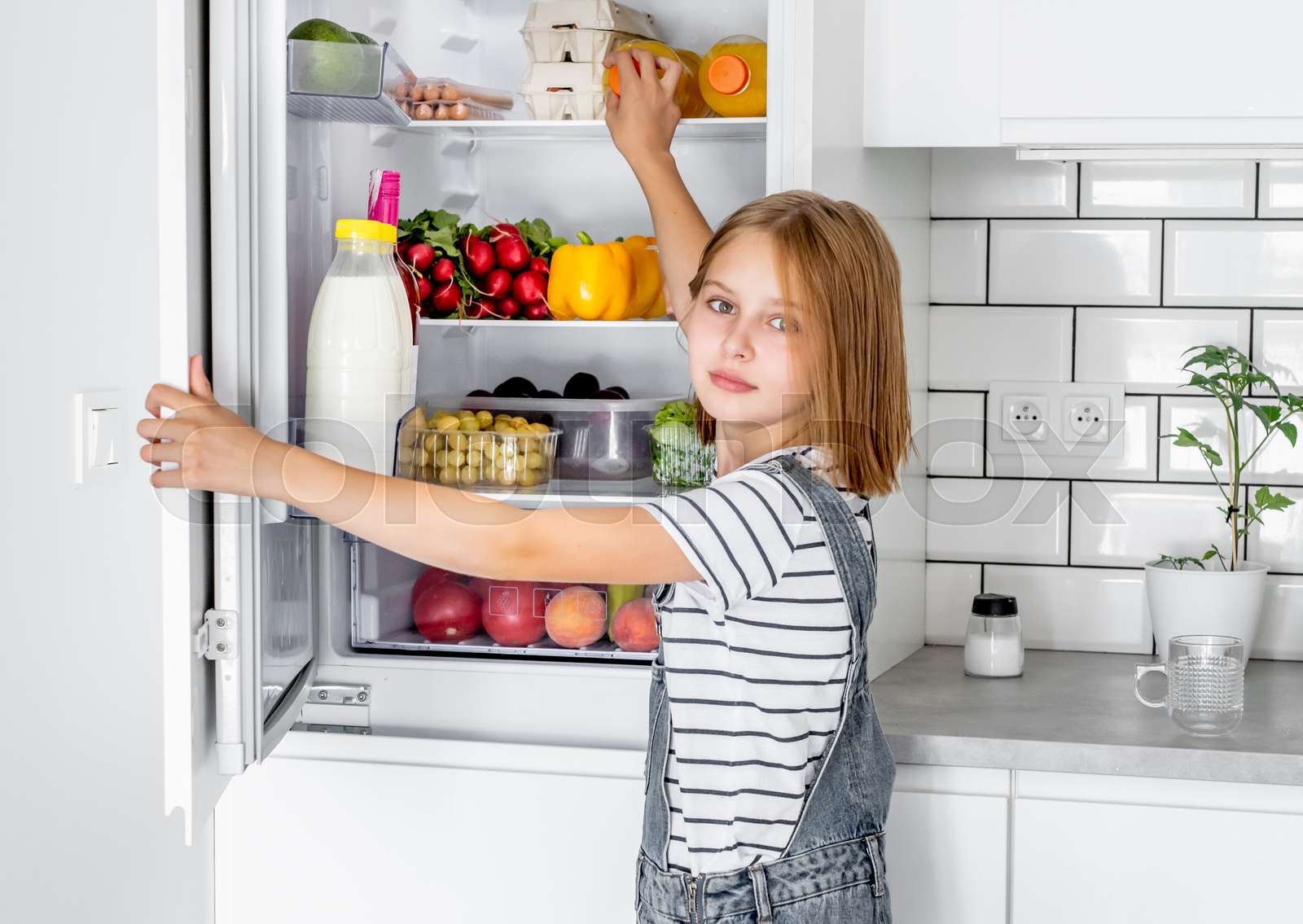 Preteen girl at kitchen | Stock image | Colourbox