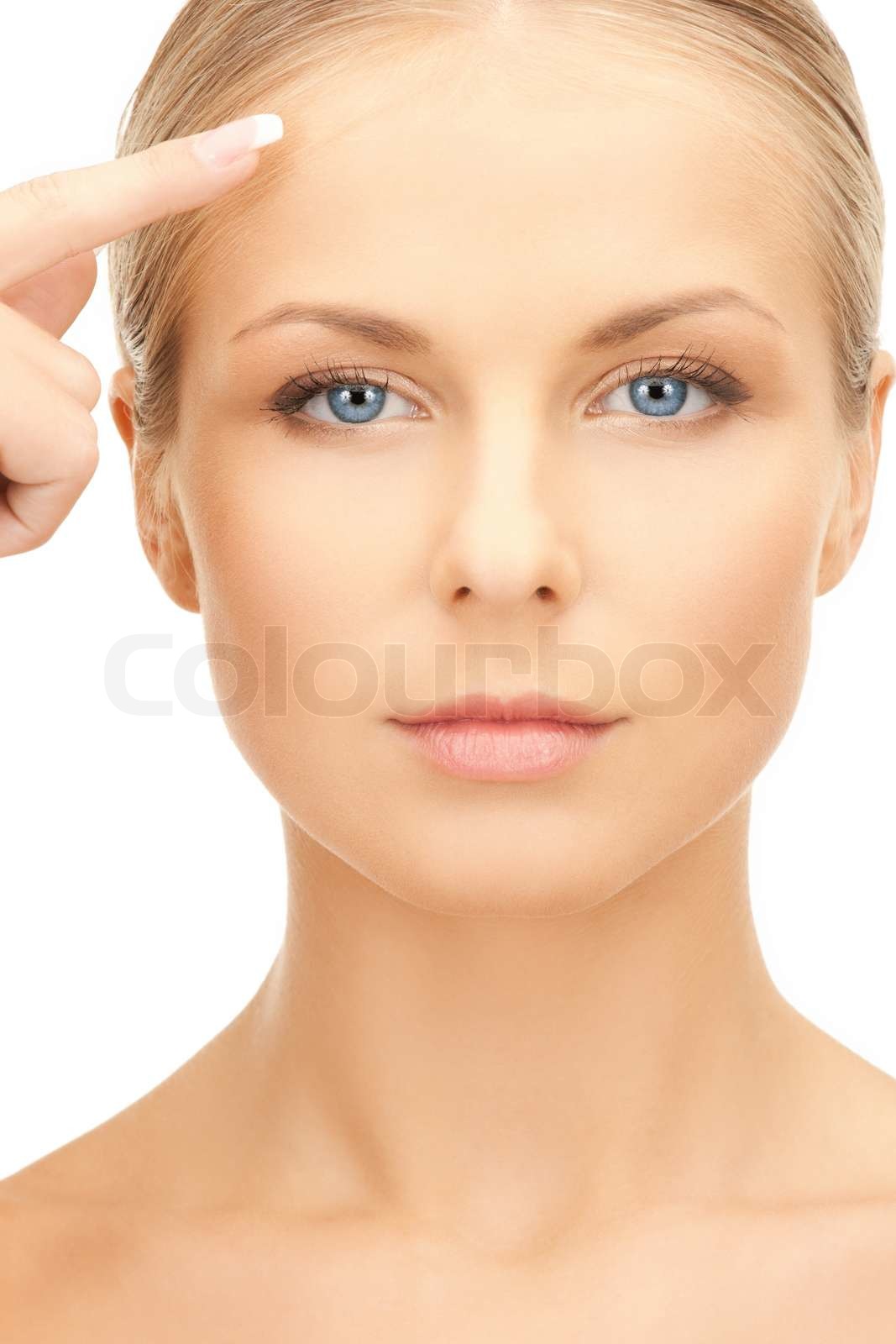 beautiful woman pointing to forehead | Stock image | Colourbox