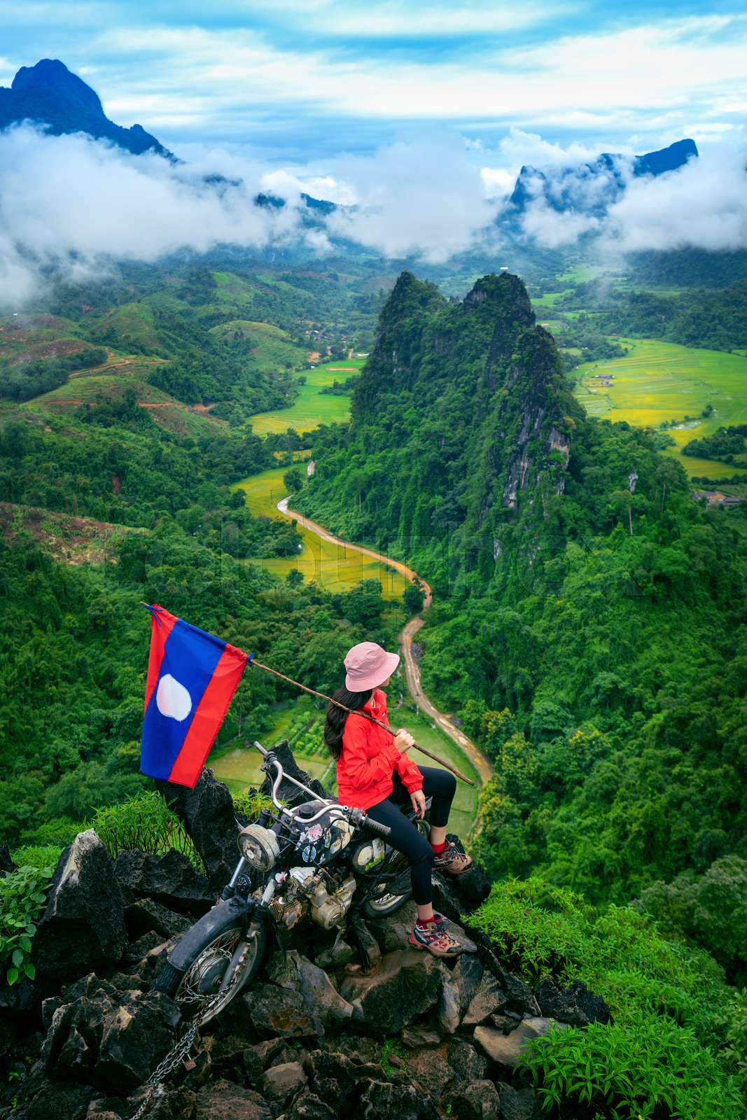 Tourist holding Lao flag on the Nam Xay Viewpoint, During the rainy ...