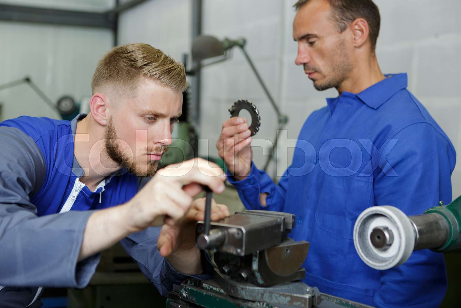 a man reparing a metal piece | Stock image | Colourbox