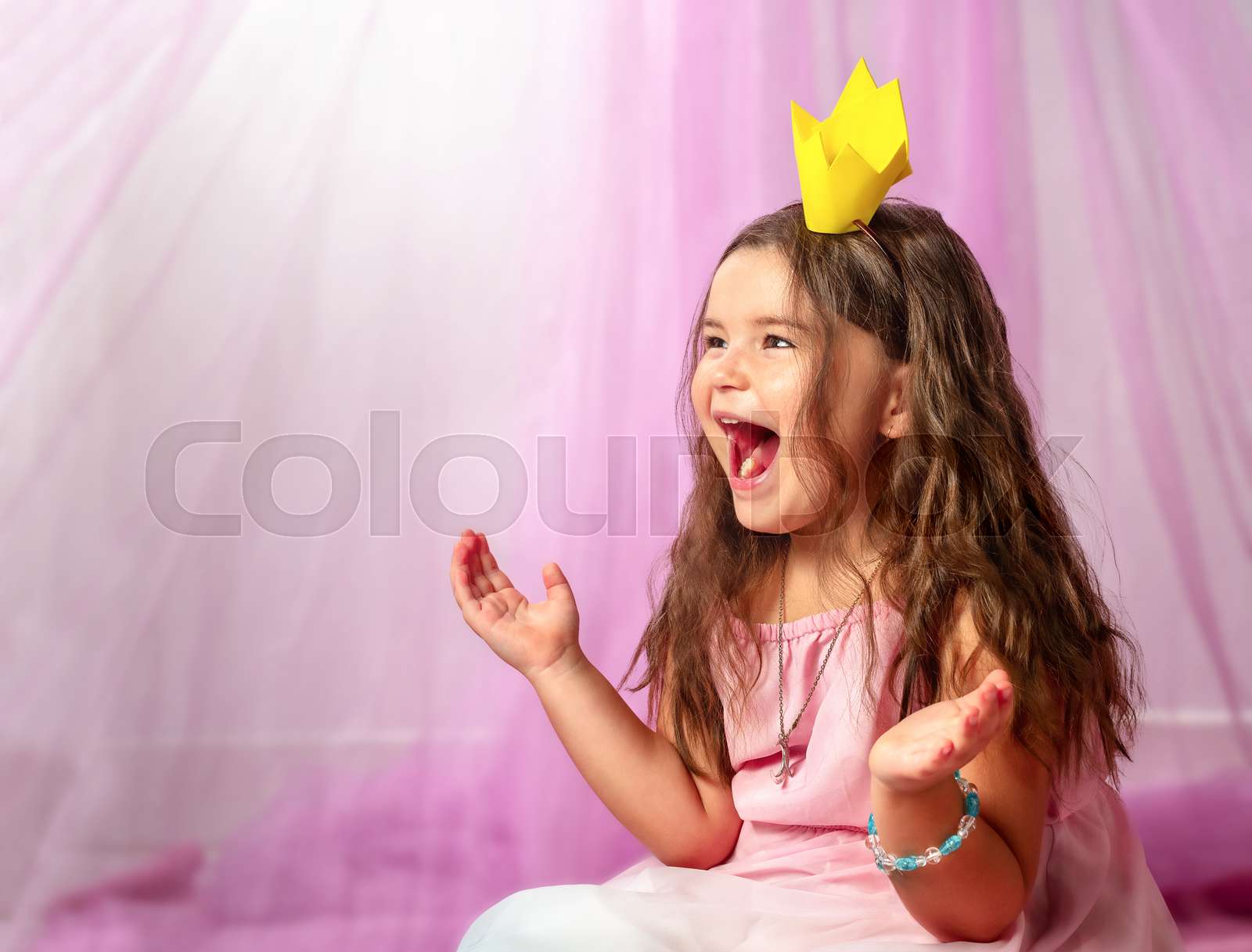 Girl princess smiles and looks away | Stock image | Colourbox